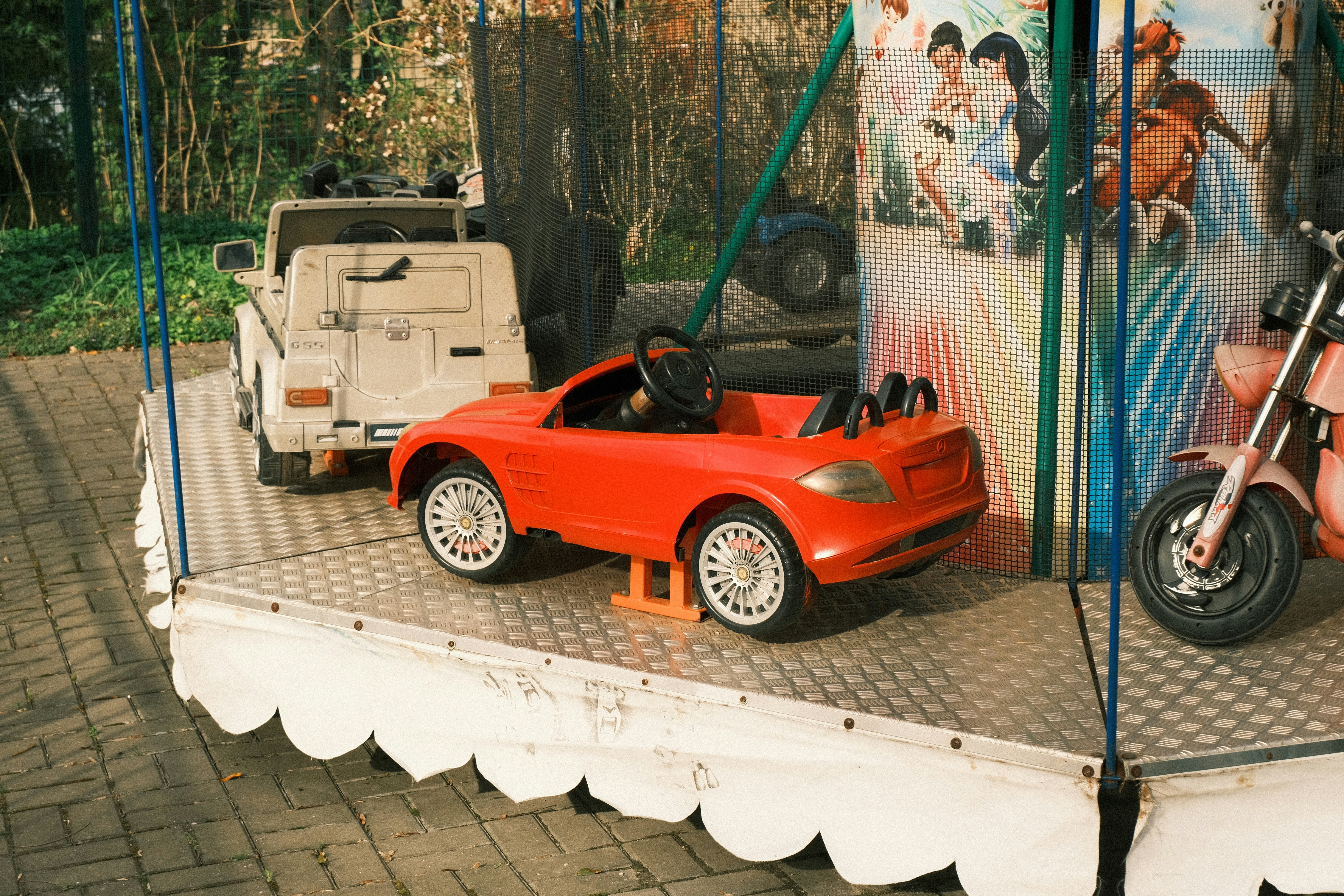 Miniature Red Convertible on a Carousel Platform