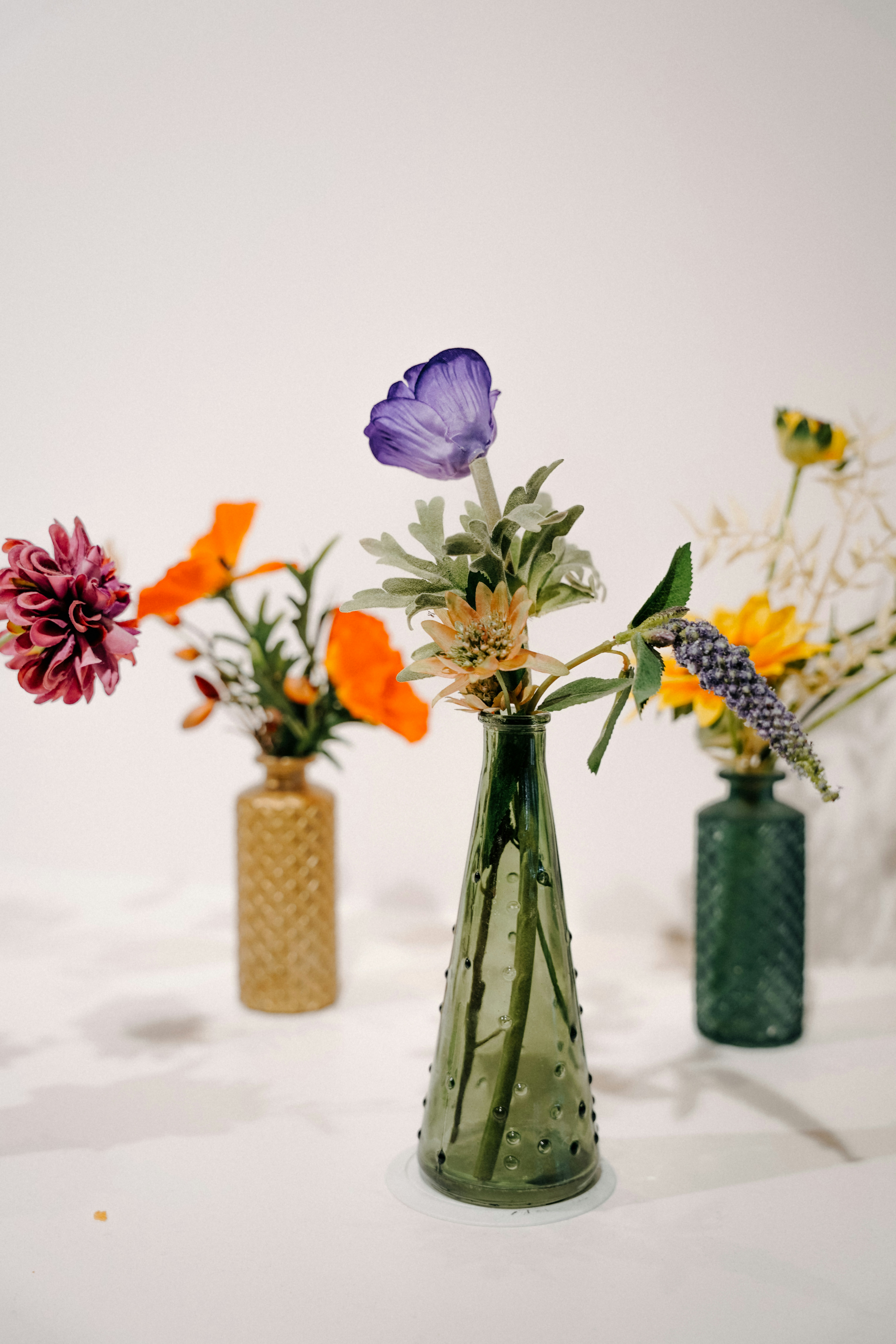 Colorful flowers are in small, decorative vases. photo – Free Flower ...