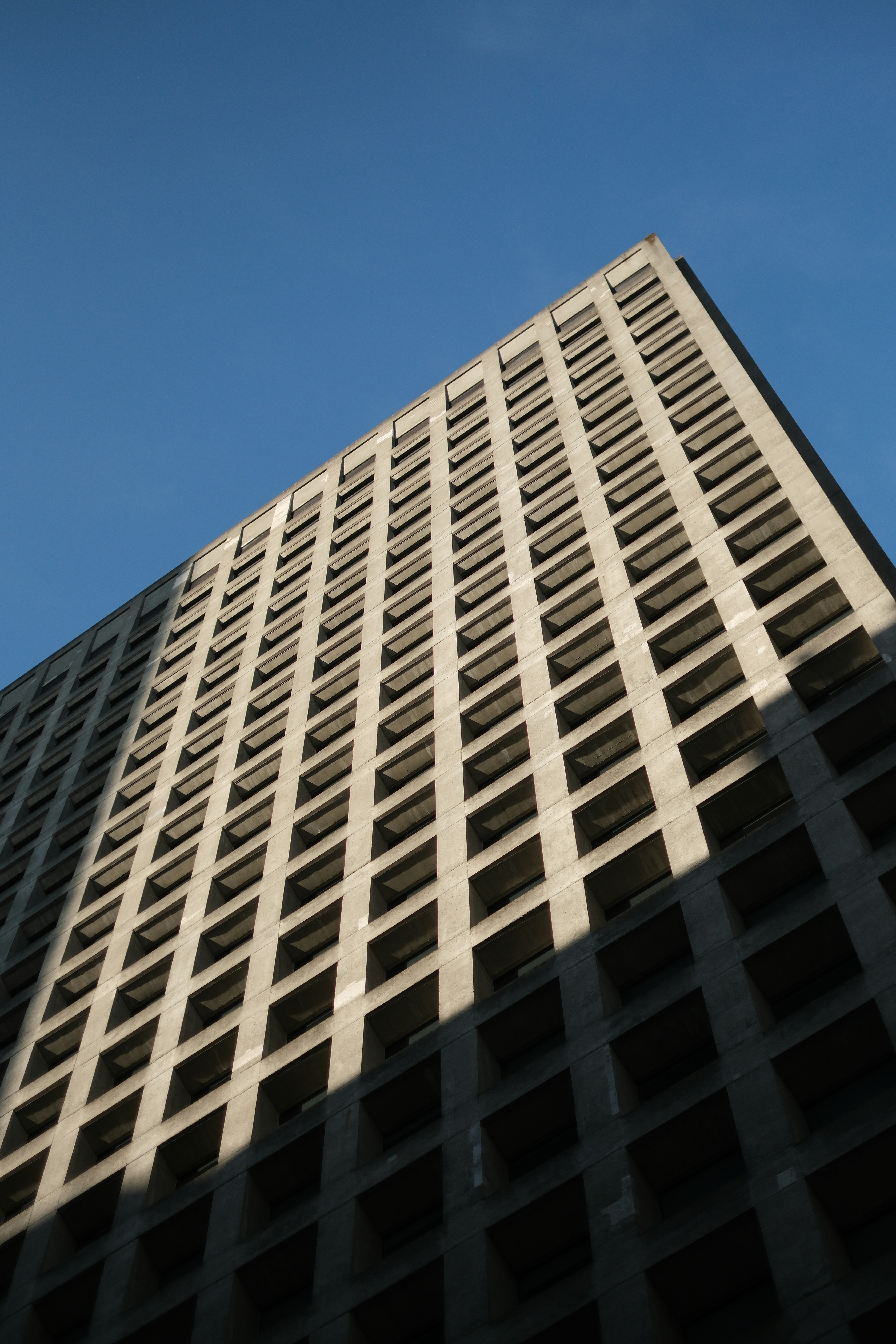 Skyscraper against the blue sky, with harsh shadows. photo – Free ...
