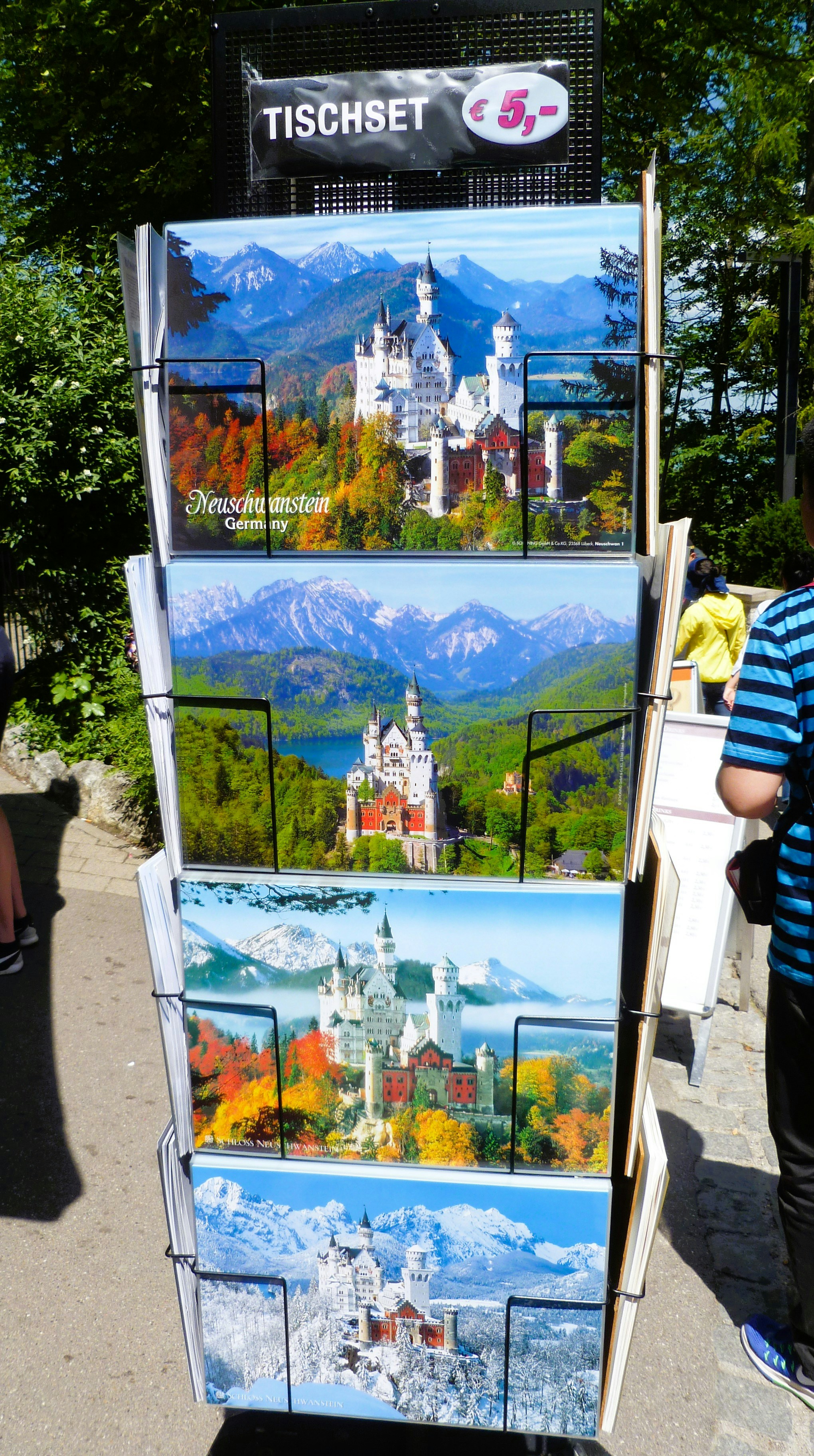 Postcards depicting neuschwanstein castle are for sale.