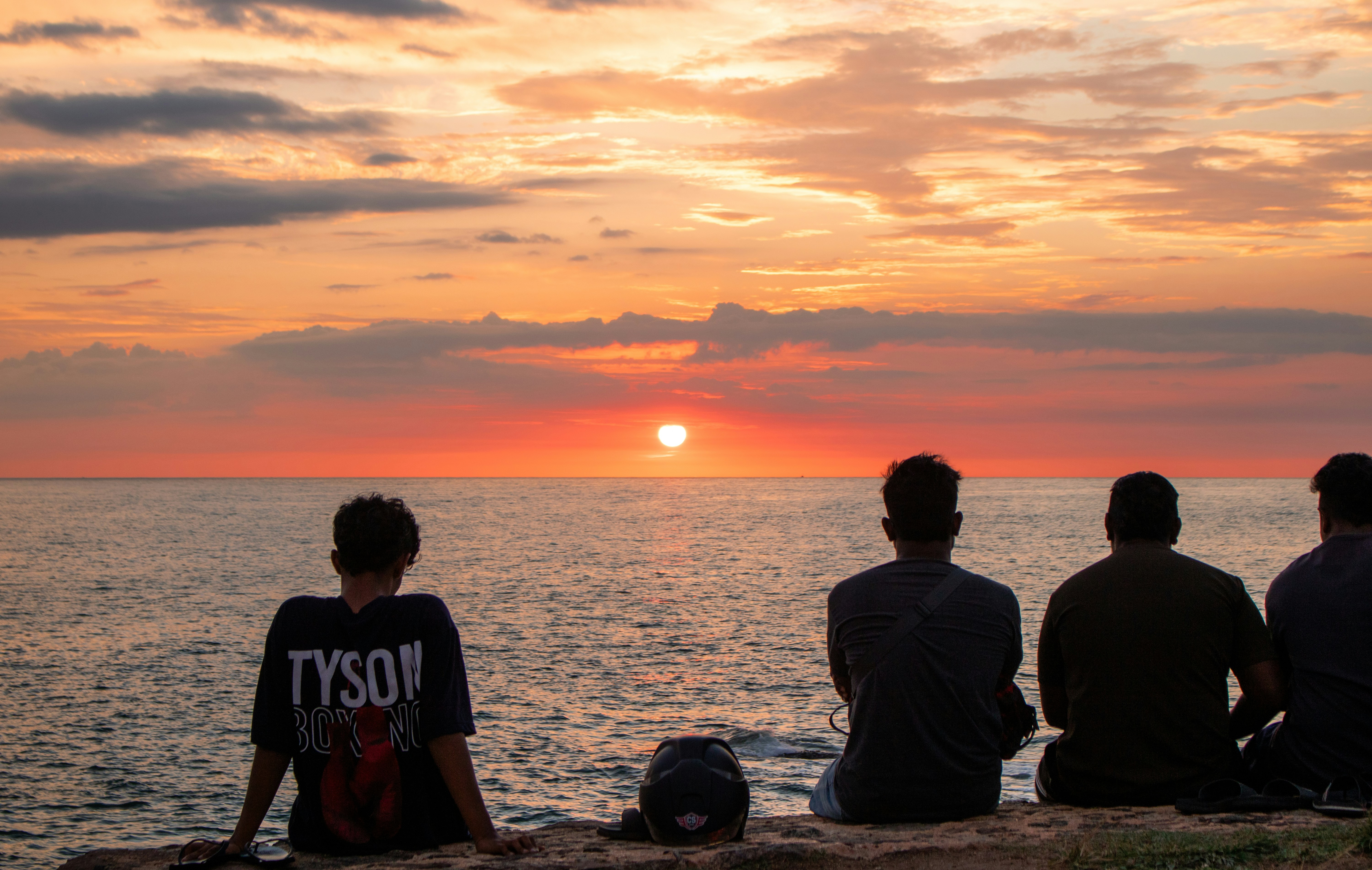 People watch the sunset over the ocean together. photo – Free People ...