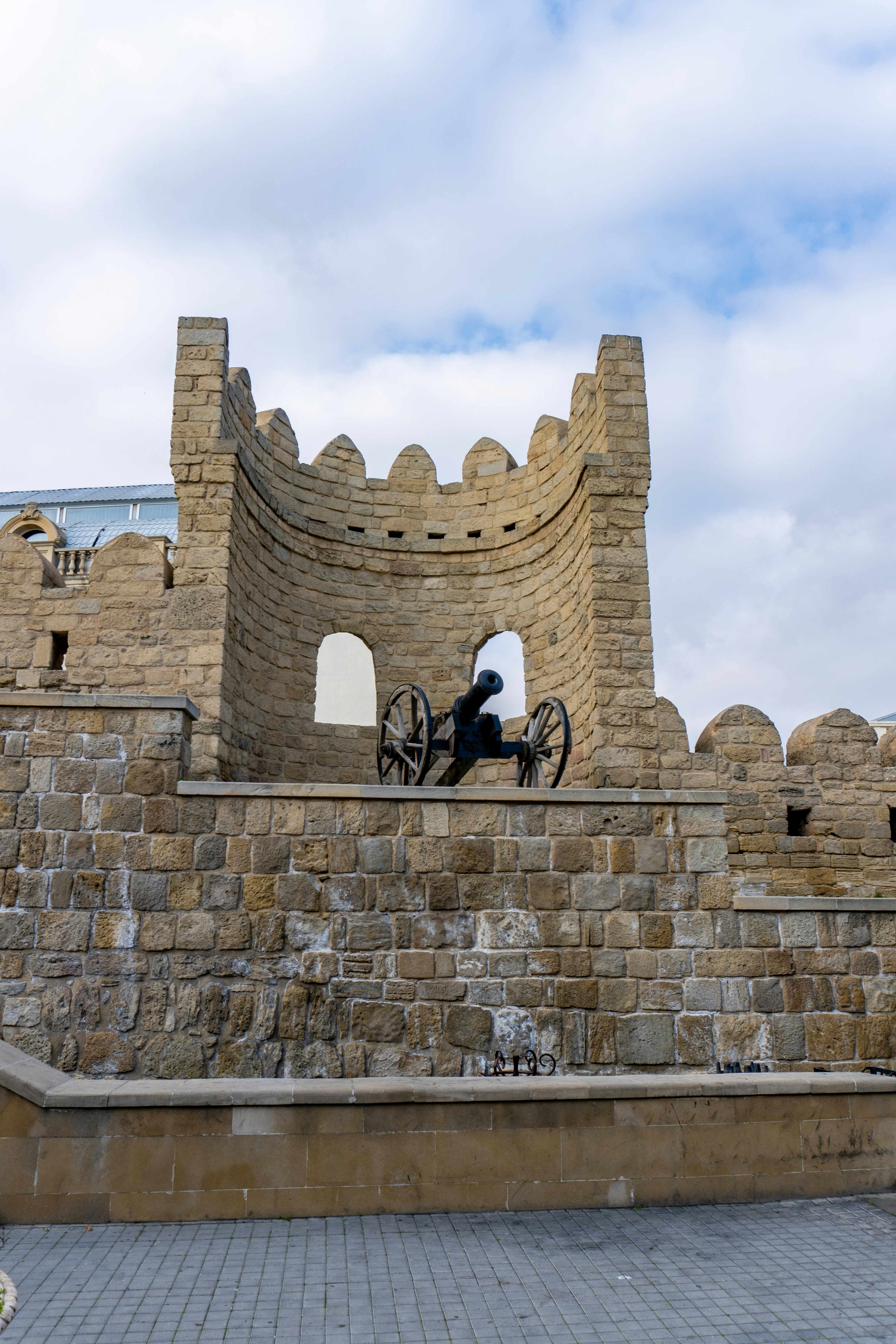 Bastion Sentinel: A Weathered Cannon Framed by Stone Arches