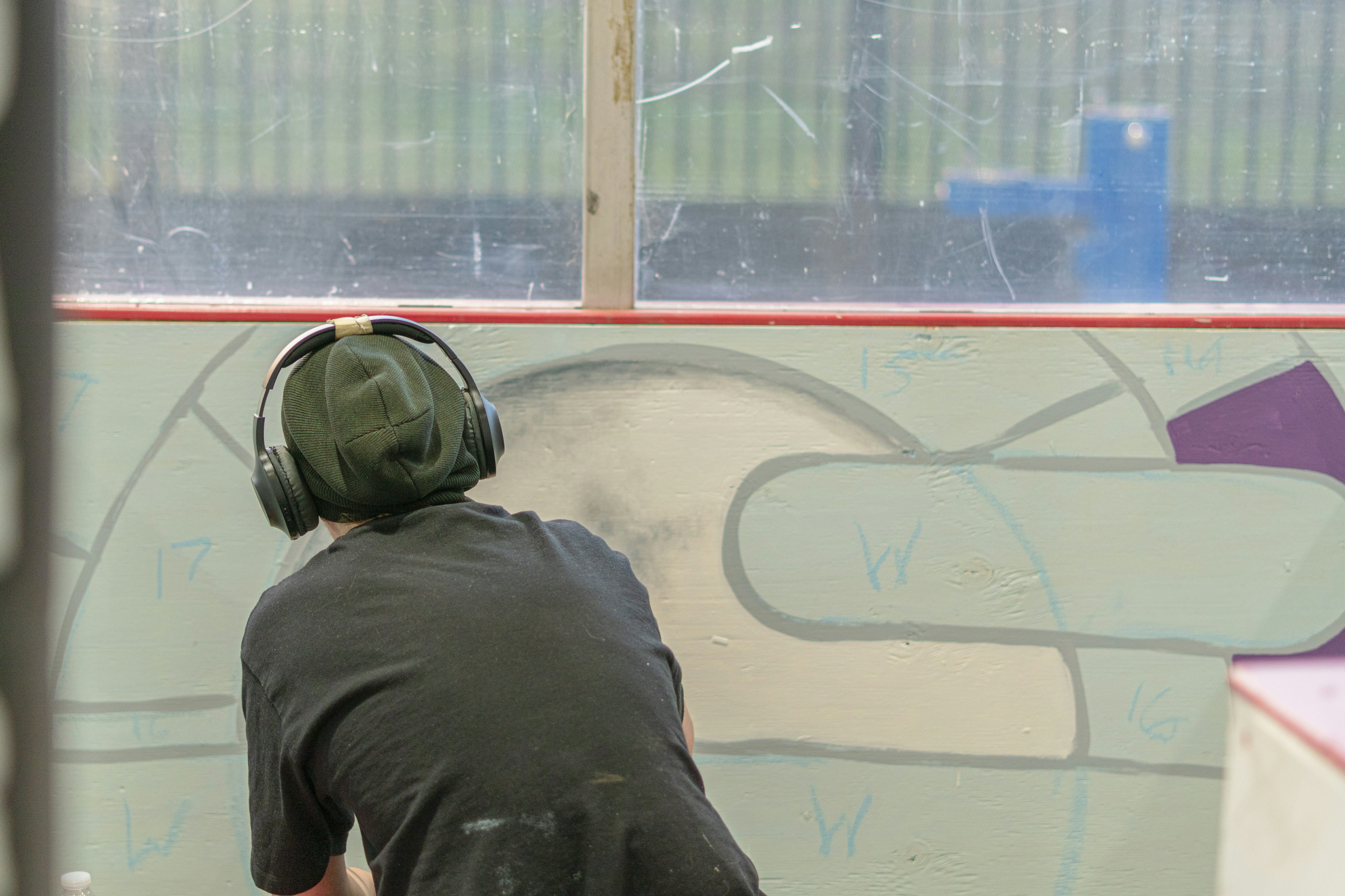 Back Turned, Walls Whisper: A Quiet Graffiti Session