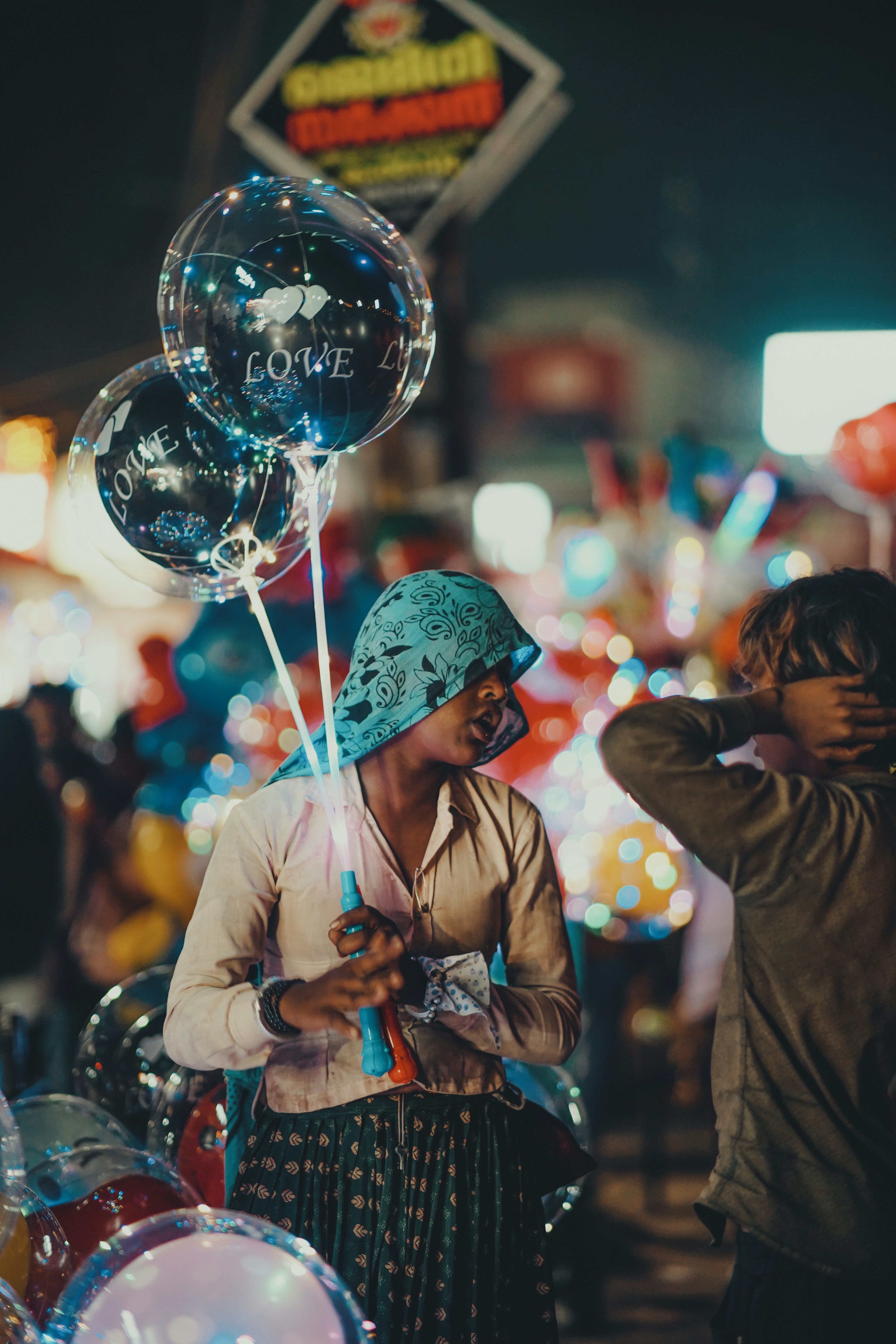 Balloons and Quiet Laughs in Neon Night Market
