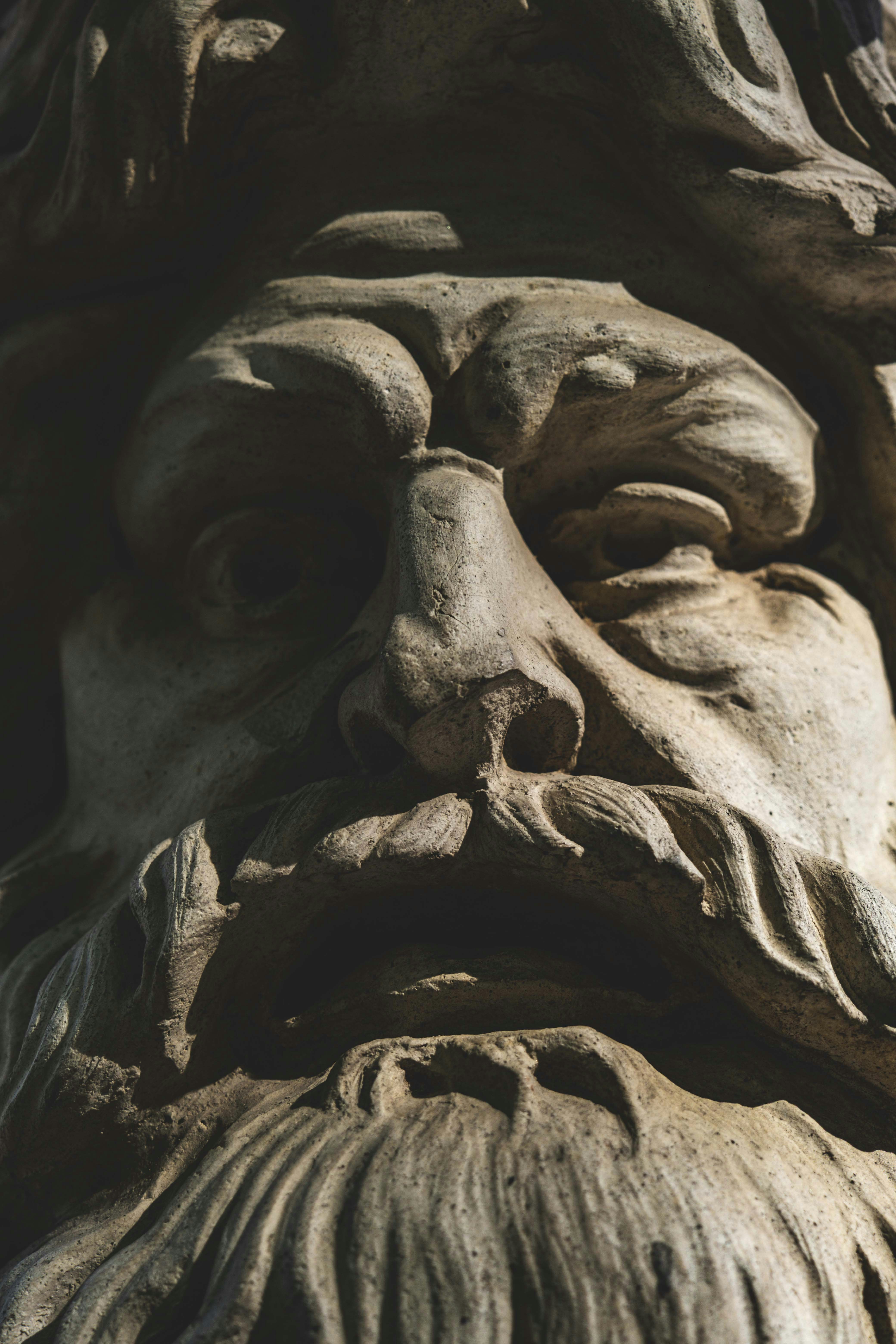 A close-up of a stone statue's face. photo – Free Art Image on Unsplash