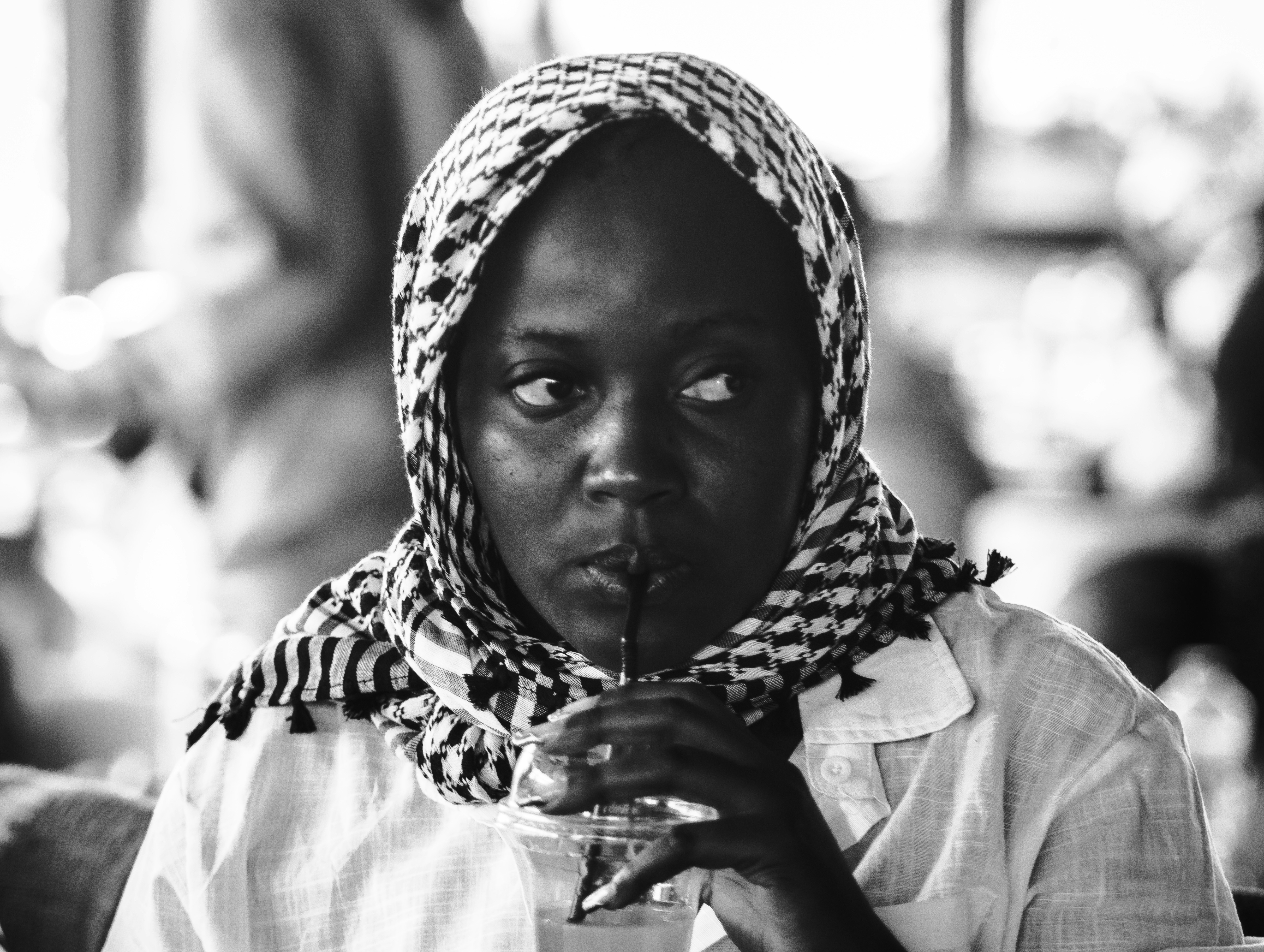 Midday Stillness: A Quiet Sip Beneath a Patterned Veil