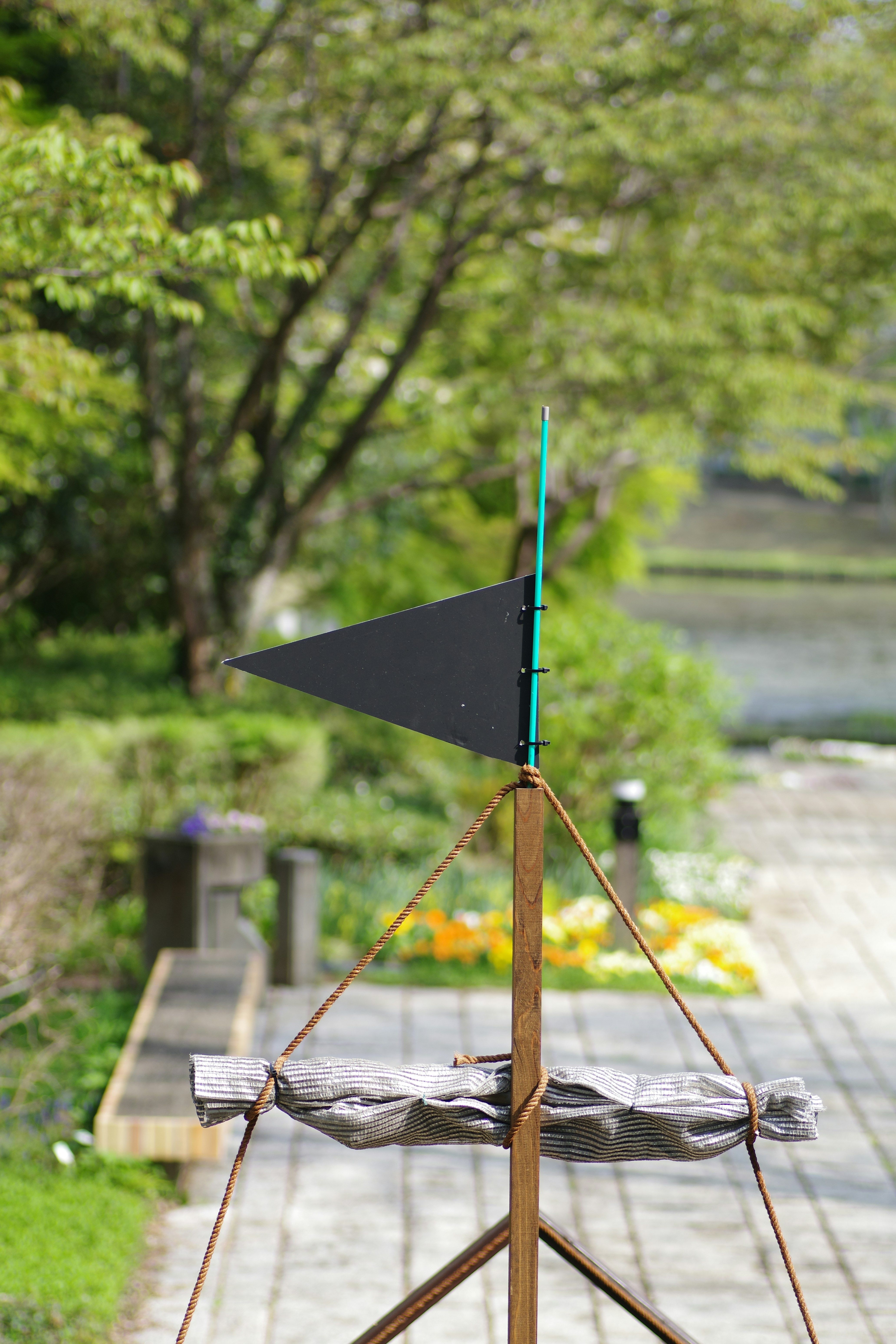 Silent Sail on a Rope-Tethered Mast in a Quiet Garden