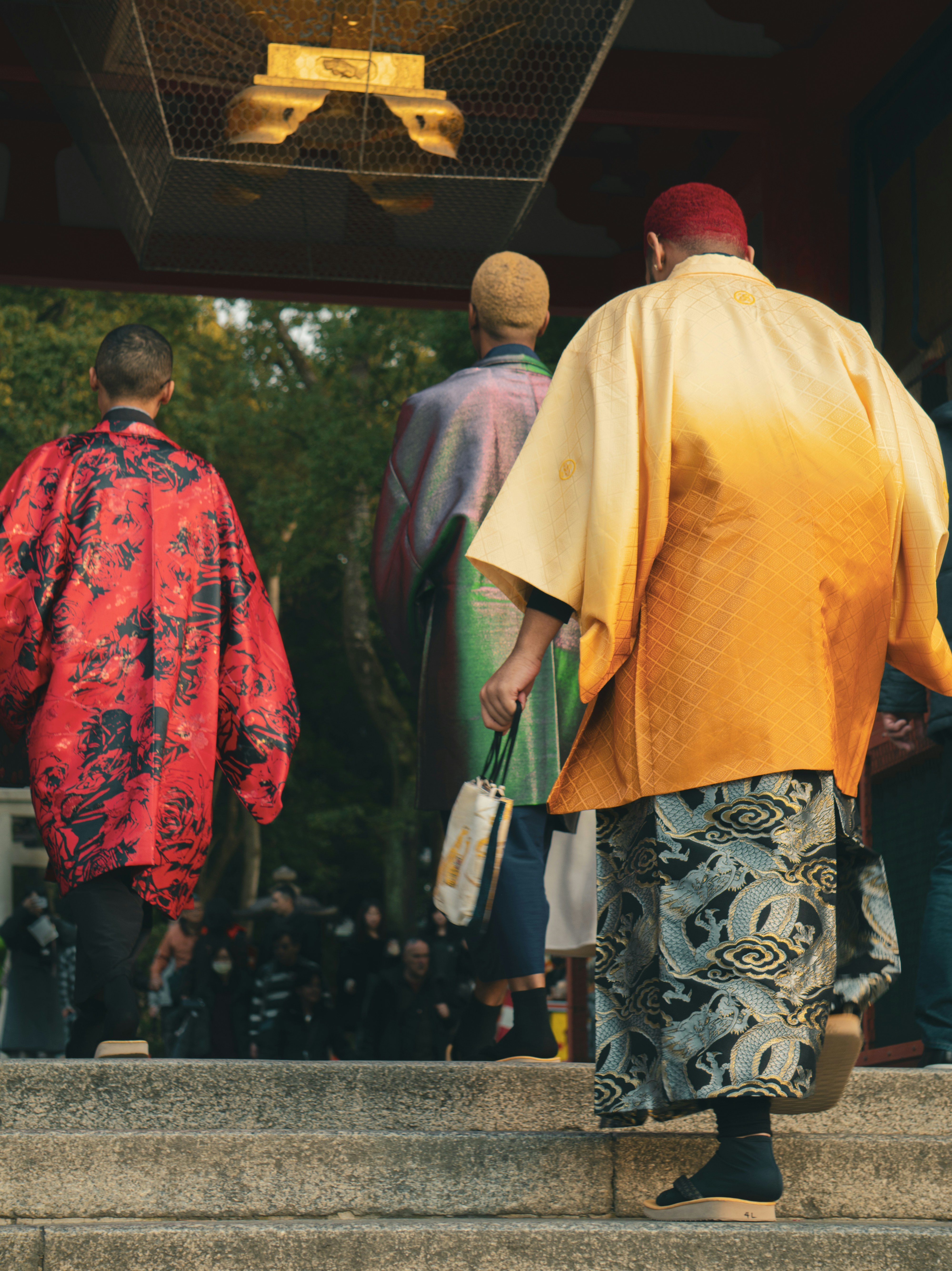 People in colorful robes enter a temple. photo – Free Japan Image on ...