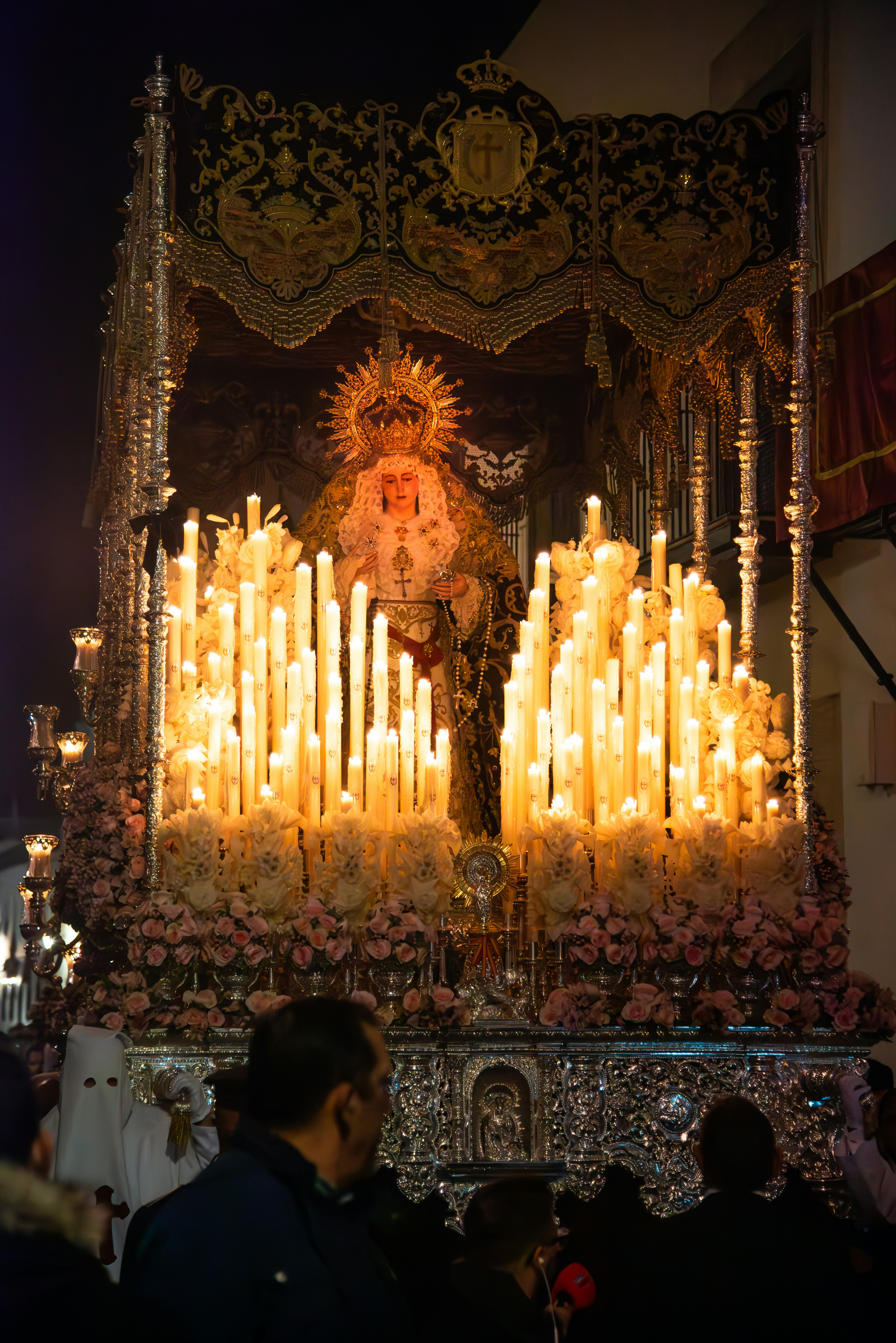 Candlelit Veneration: Marian Icon on a Silver Carriage Amid a Sea of Candles