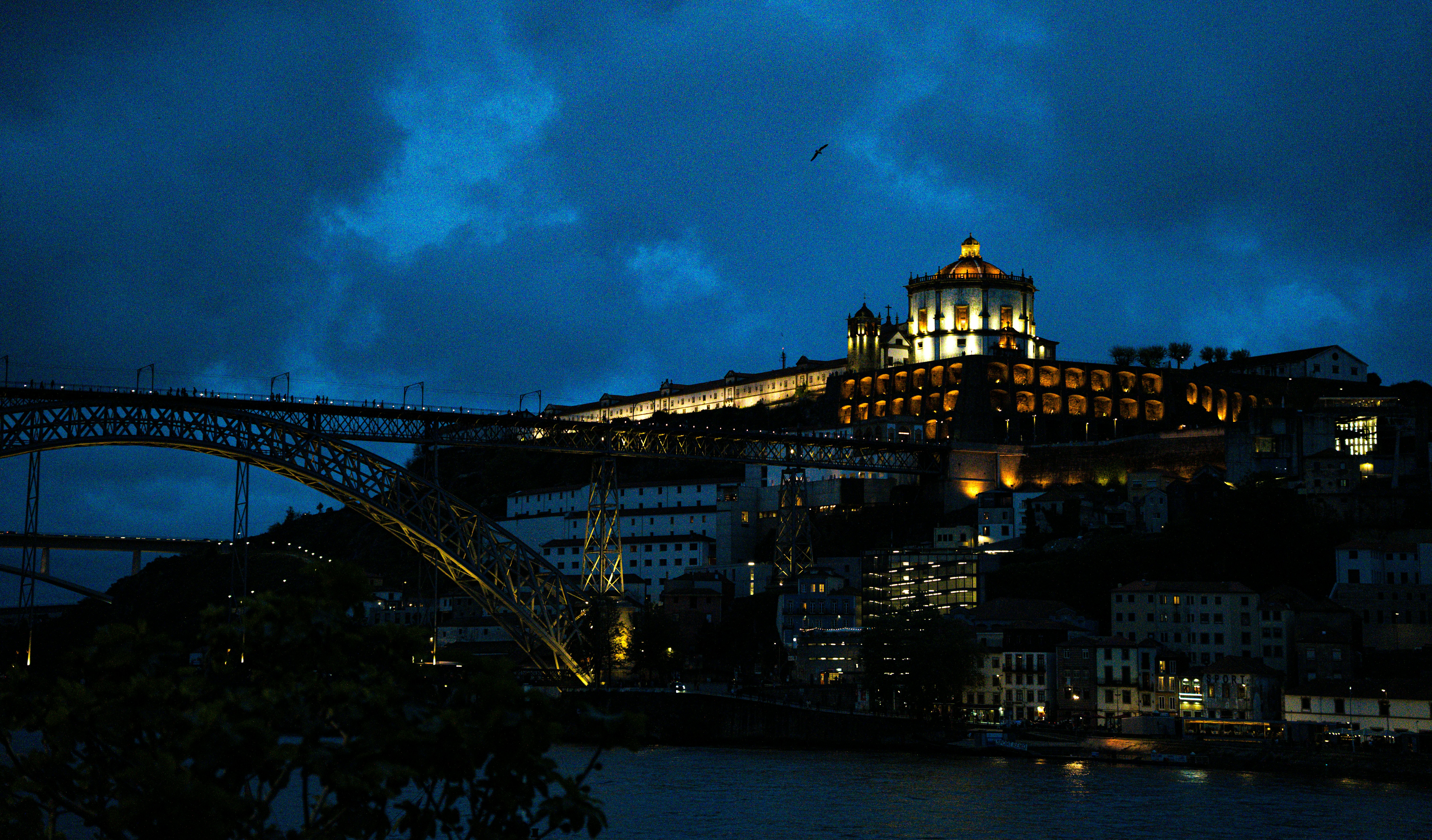 Illuminated fortress atop the hill: night scene over the Douro