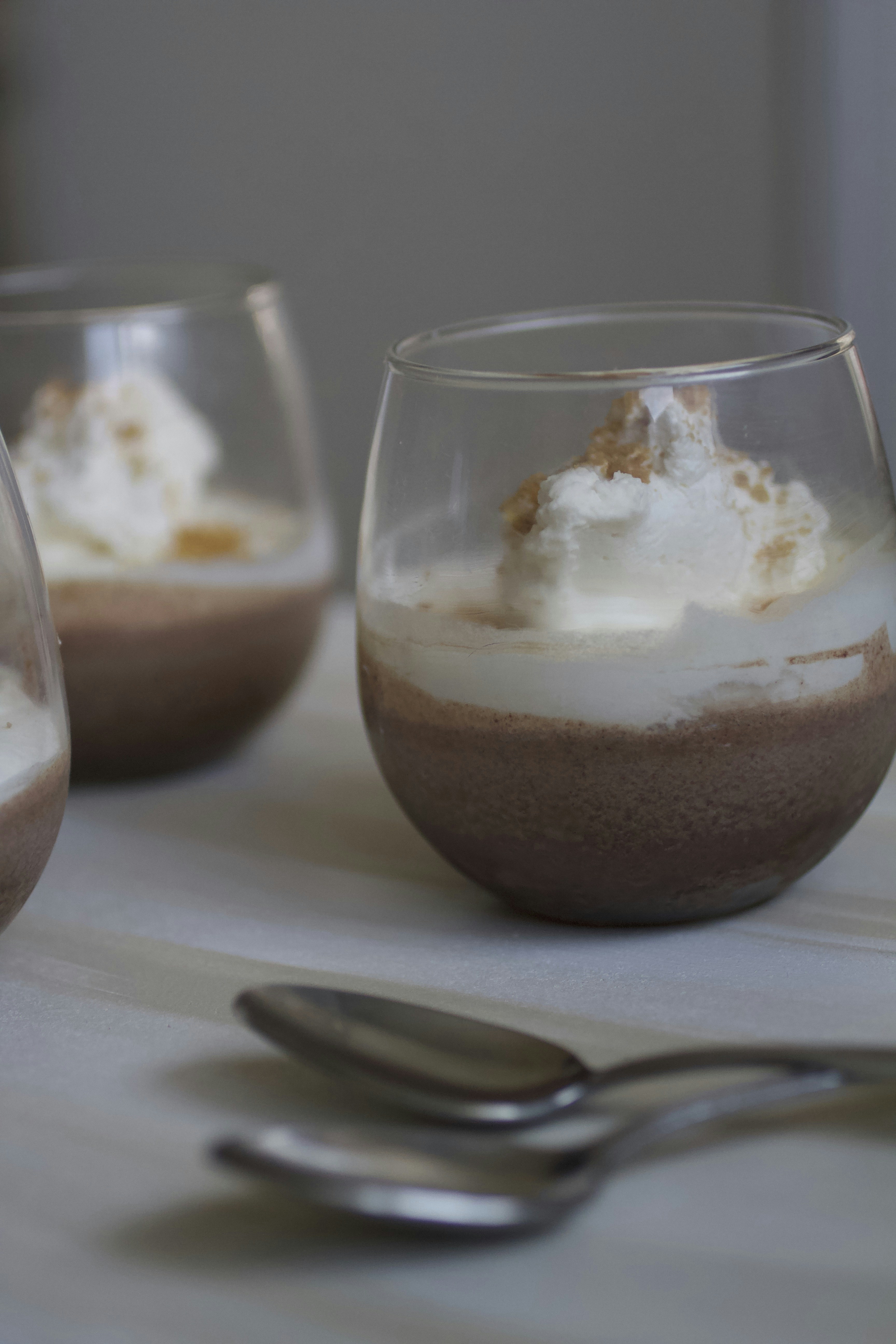 Gluten Free Gingerbread Chocolate Coconut Mousse Trifle | Chocolate mousse with whipped cream, served in glasses.