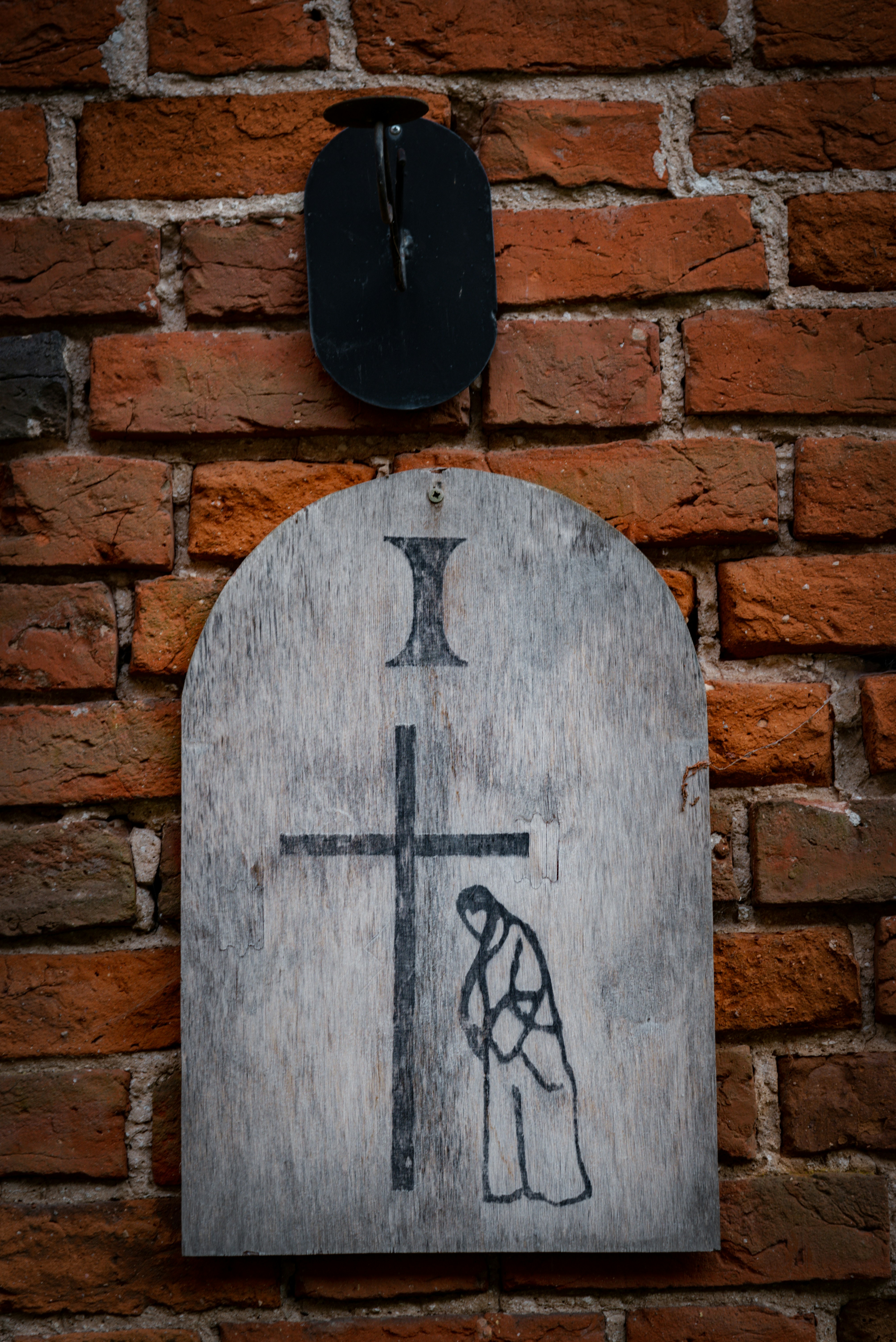 A religious sign displays a cross and figure. photo – Free Woman Image ...