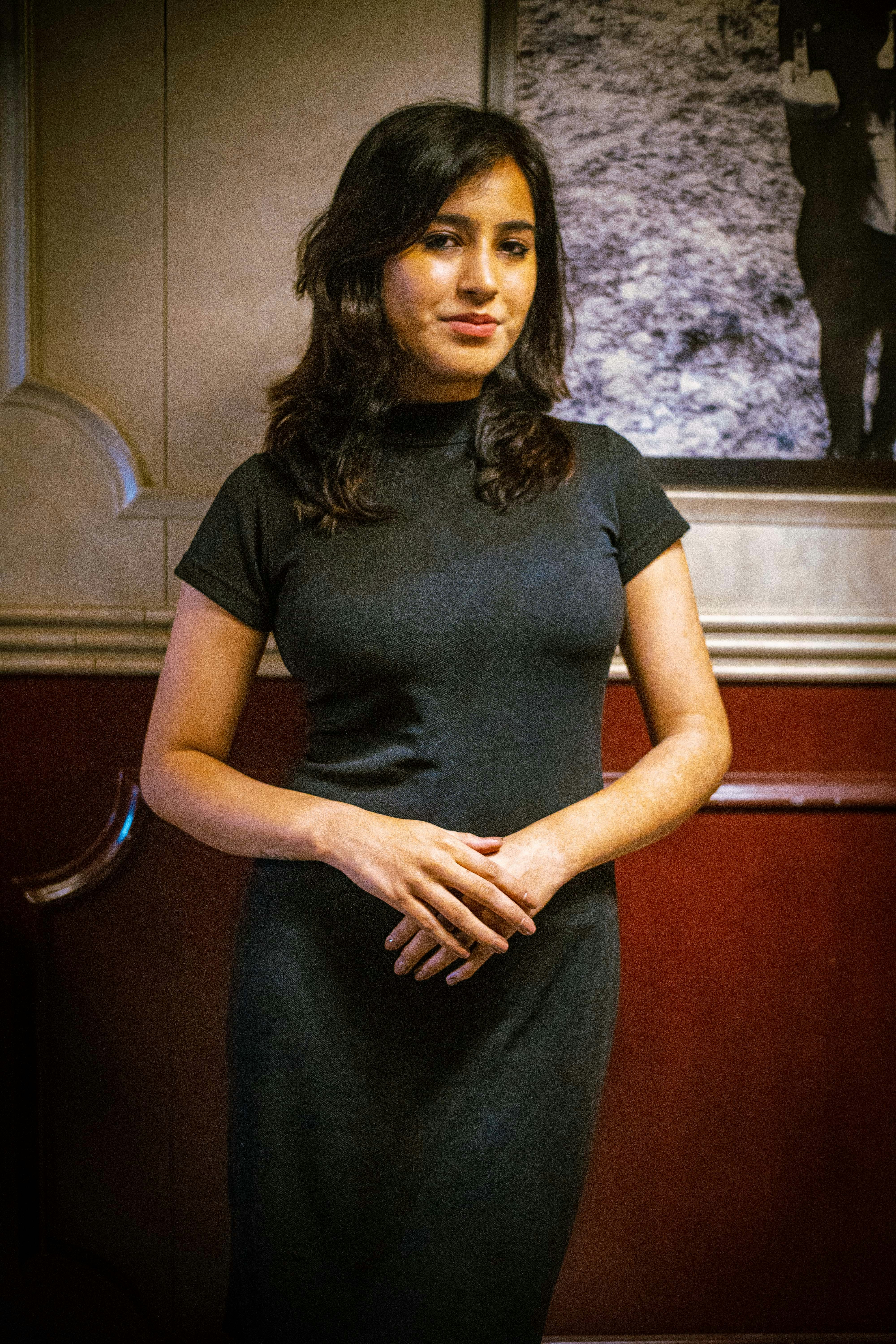 A woman poses in a black dress. photo – Free Portrait Image on Unsplash