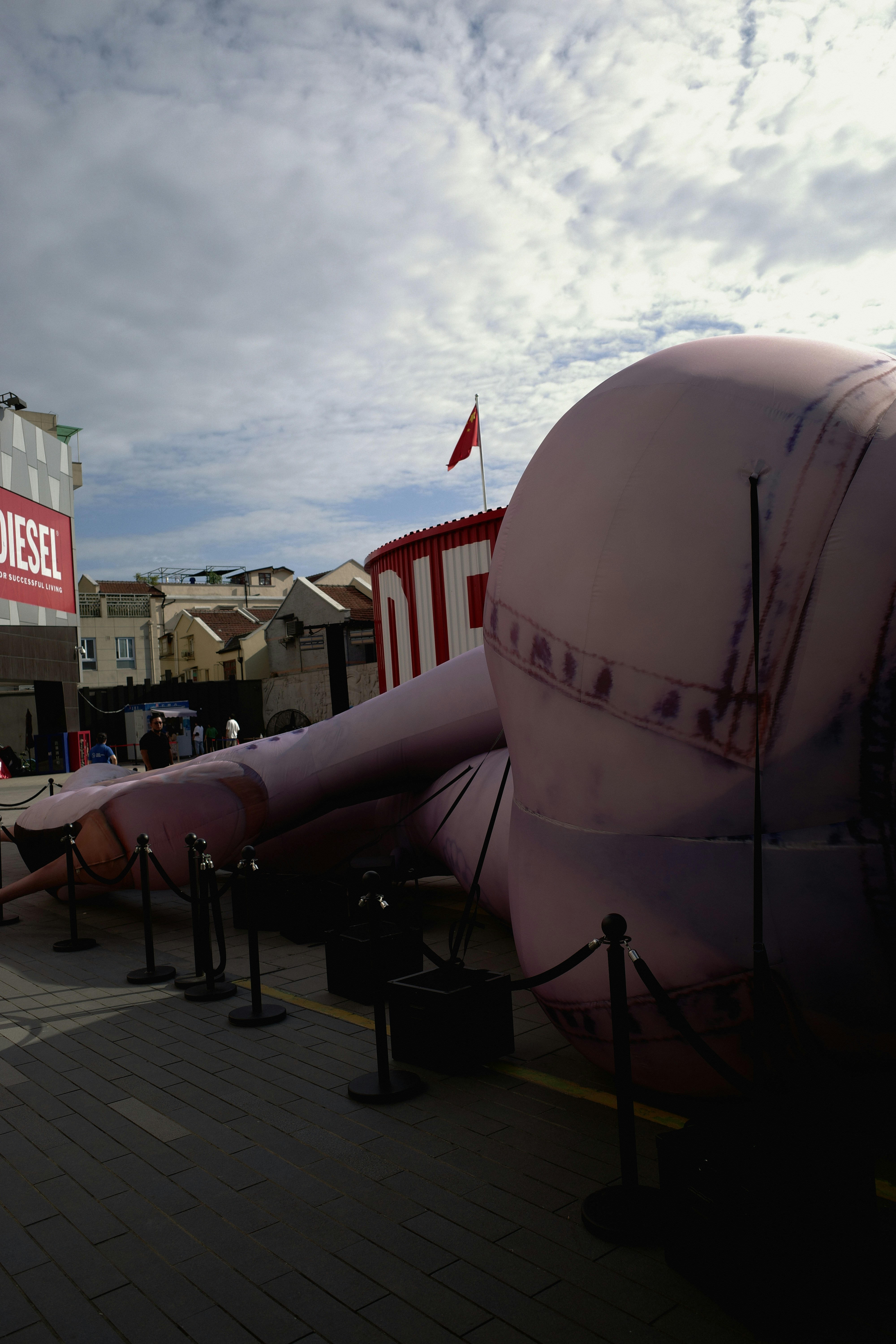 A large, inflatable figure lies next to a diesel sign. photo – Free ...