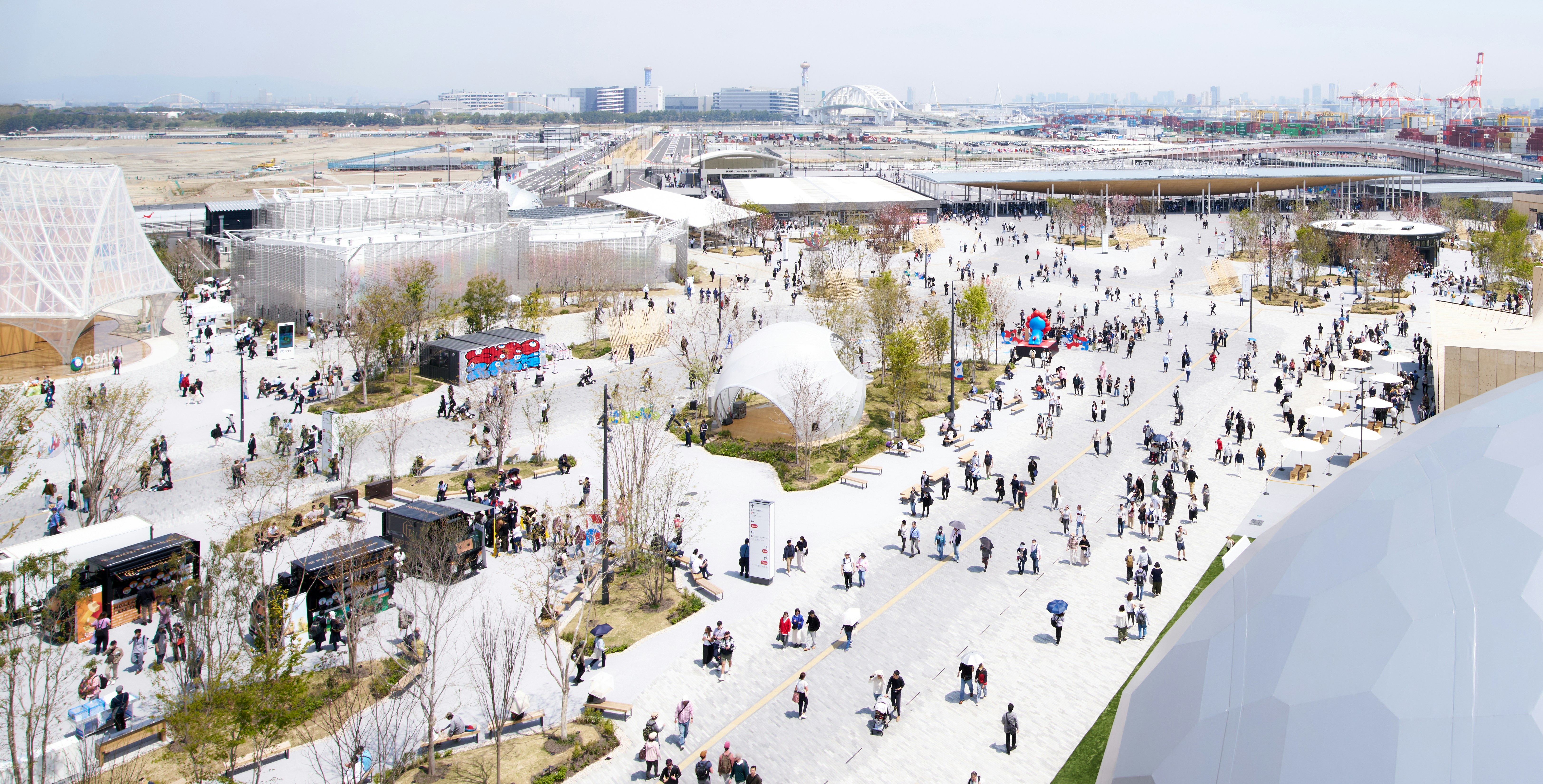 People are walking through an outdoor event space. photo – Free City ...