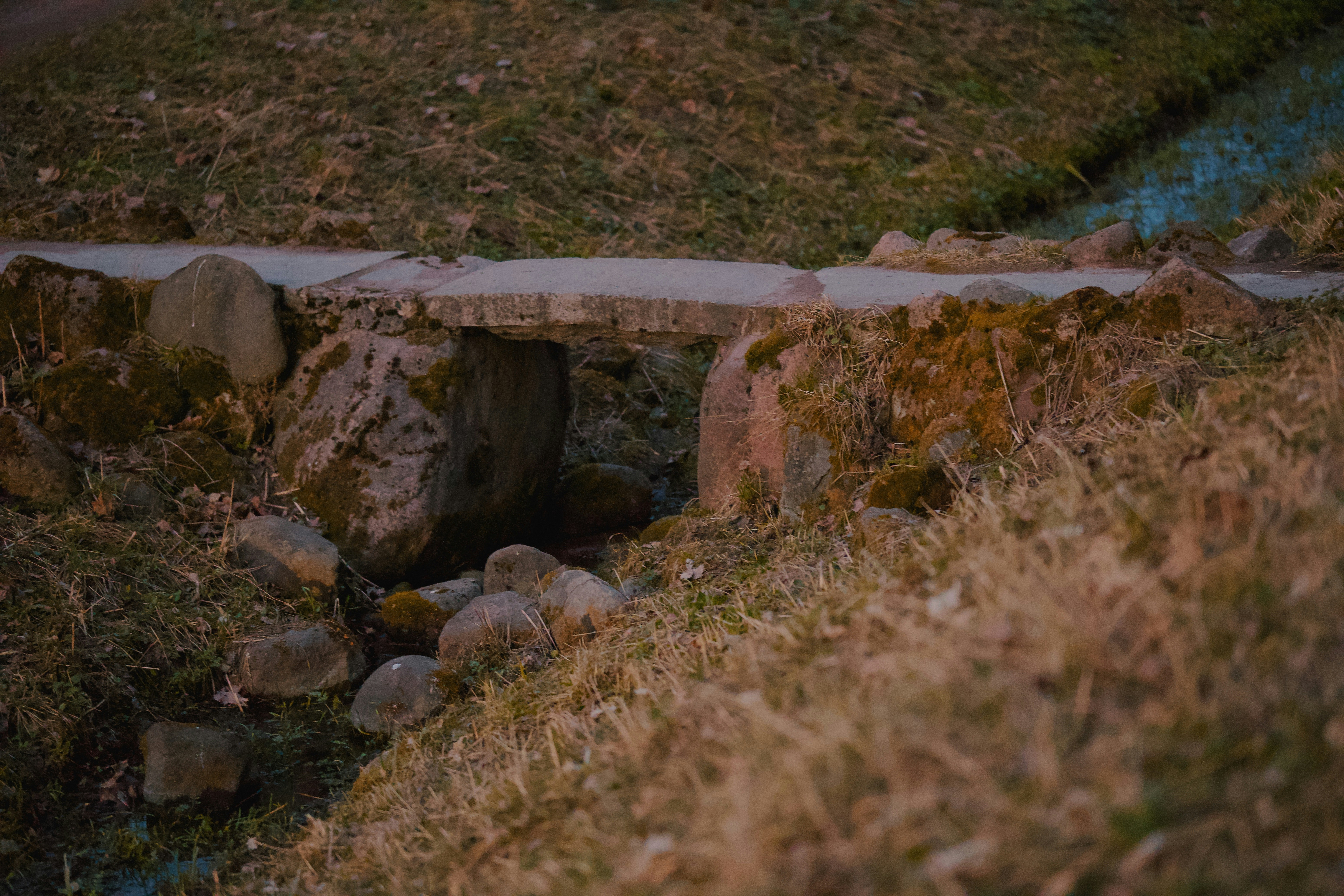 Dusk on the Pebble Bridge: A Quiet Crossing Over a Narrow Rivulet