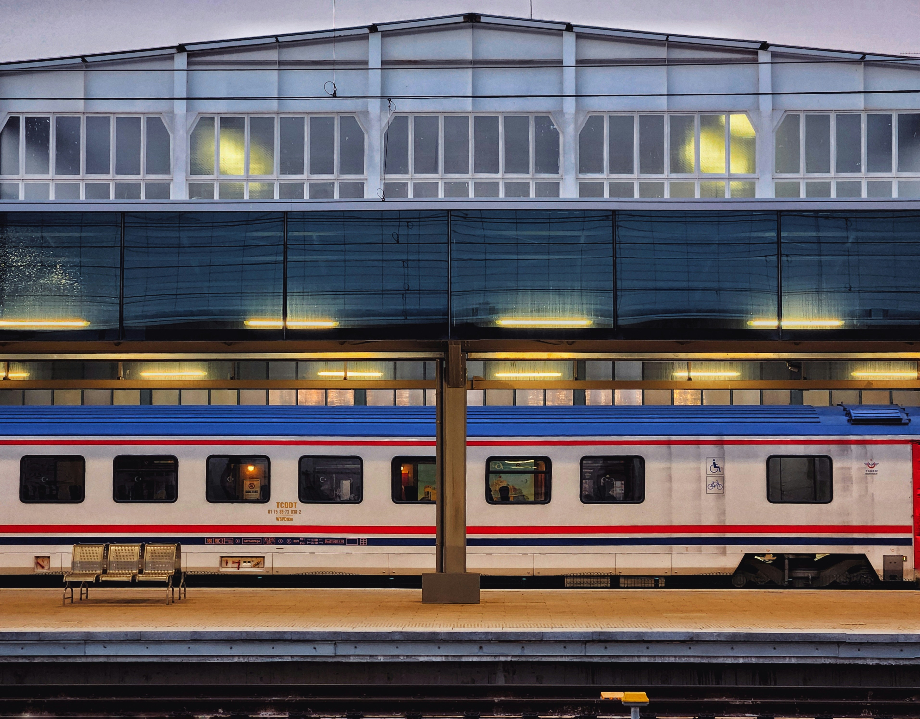 Central Pillar Framing a Train Under a Glass-Panel Canopy