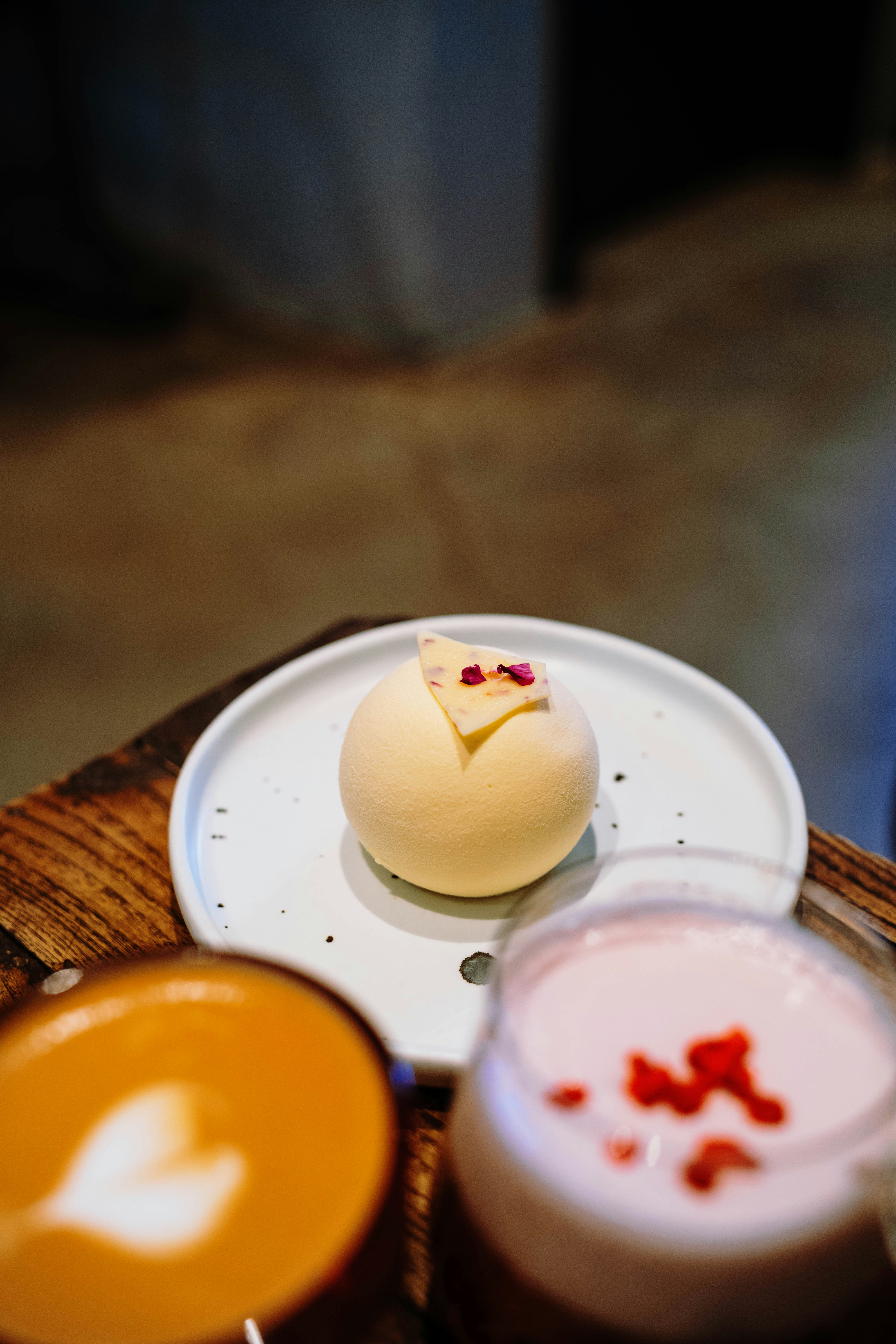 Vanilla Sphere on White Plate: A Rustic Café Moment with Two Creamy Beverages