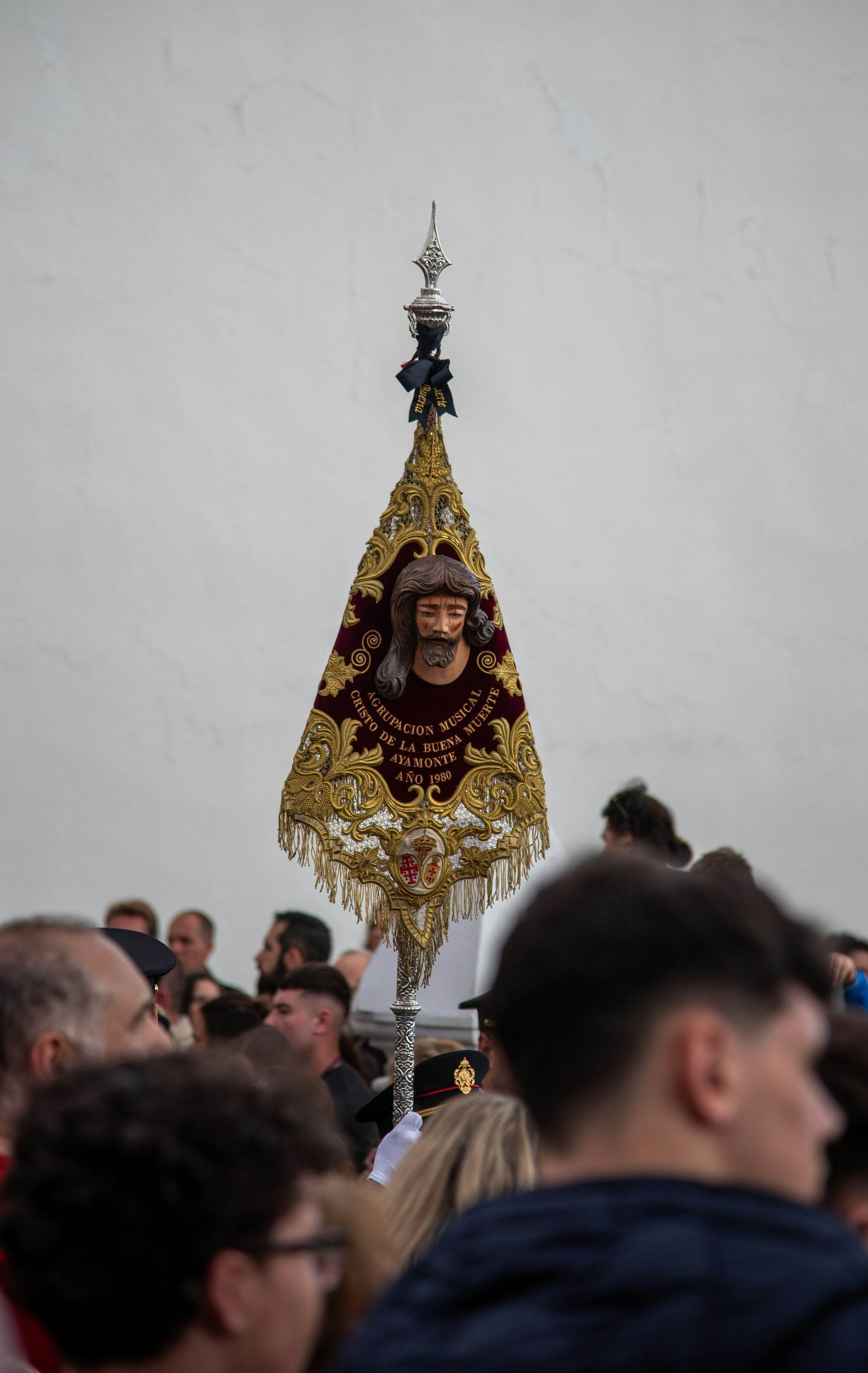 Ornate Banner Piercing the Crowd: A Sacred Standard Borne Aloft