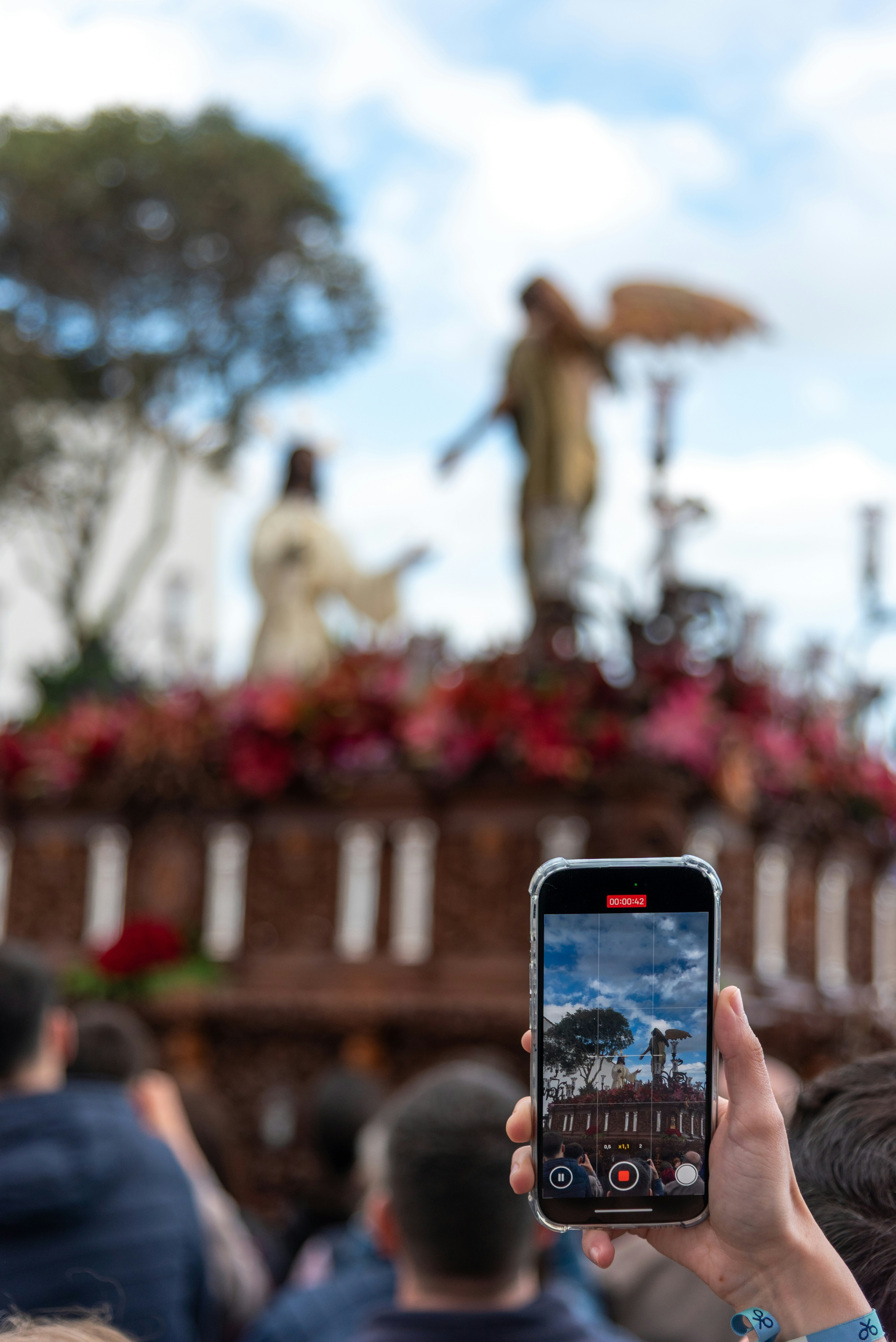 Parade in Focus: A Handheld Snapshot of a Floral Statue Float