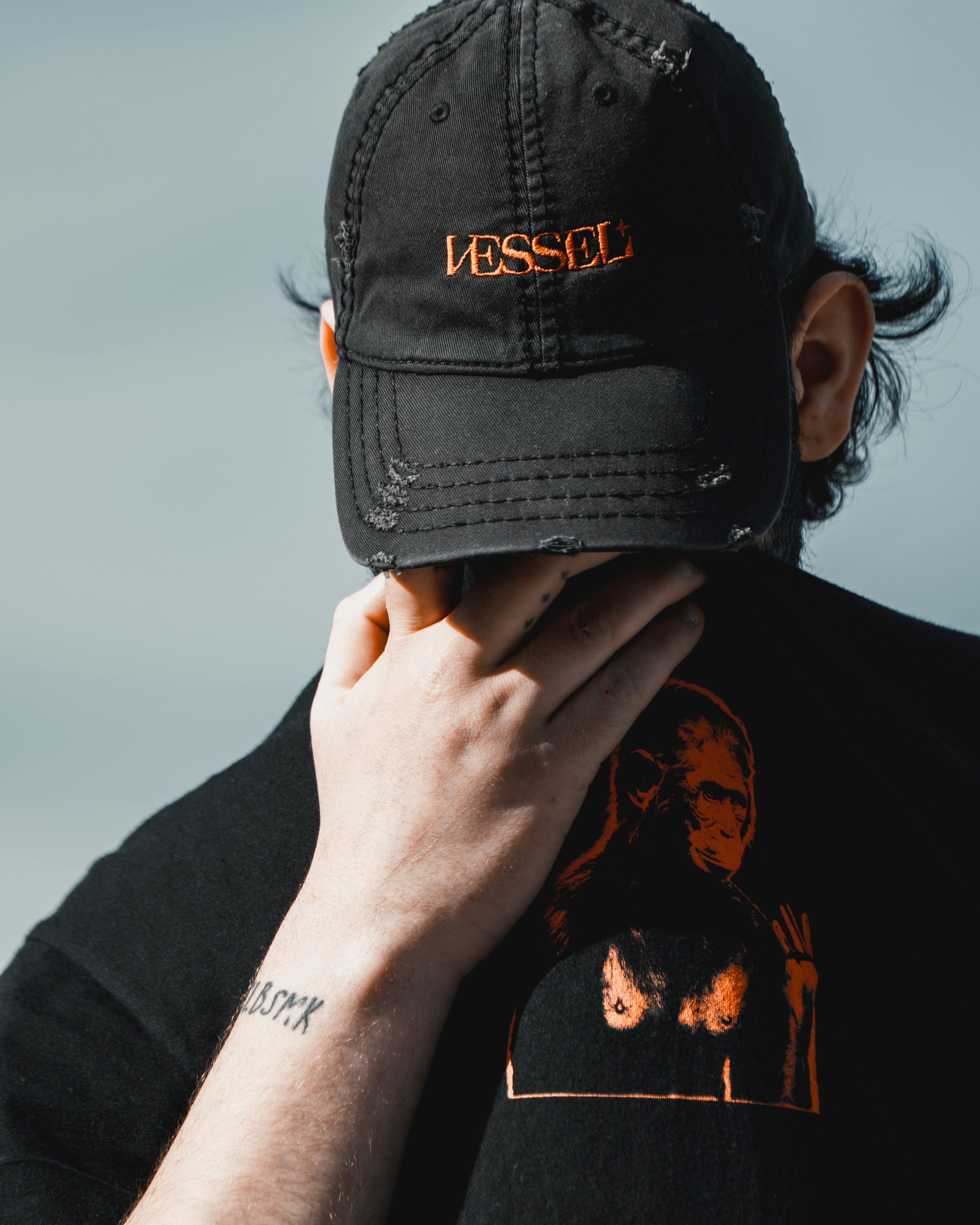 Hooded portrait: a shaded gaze beneath a worn cap