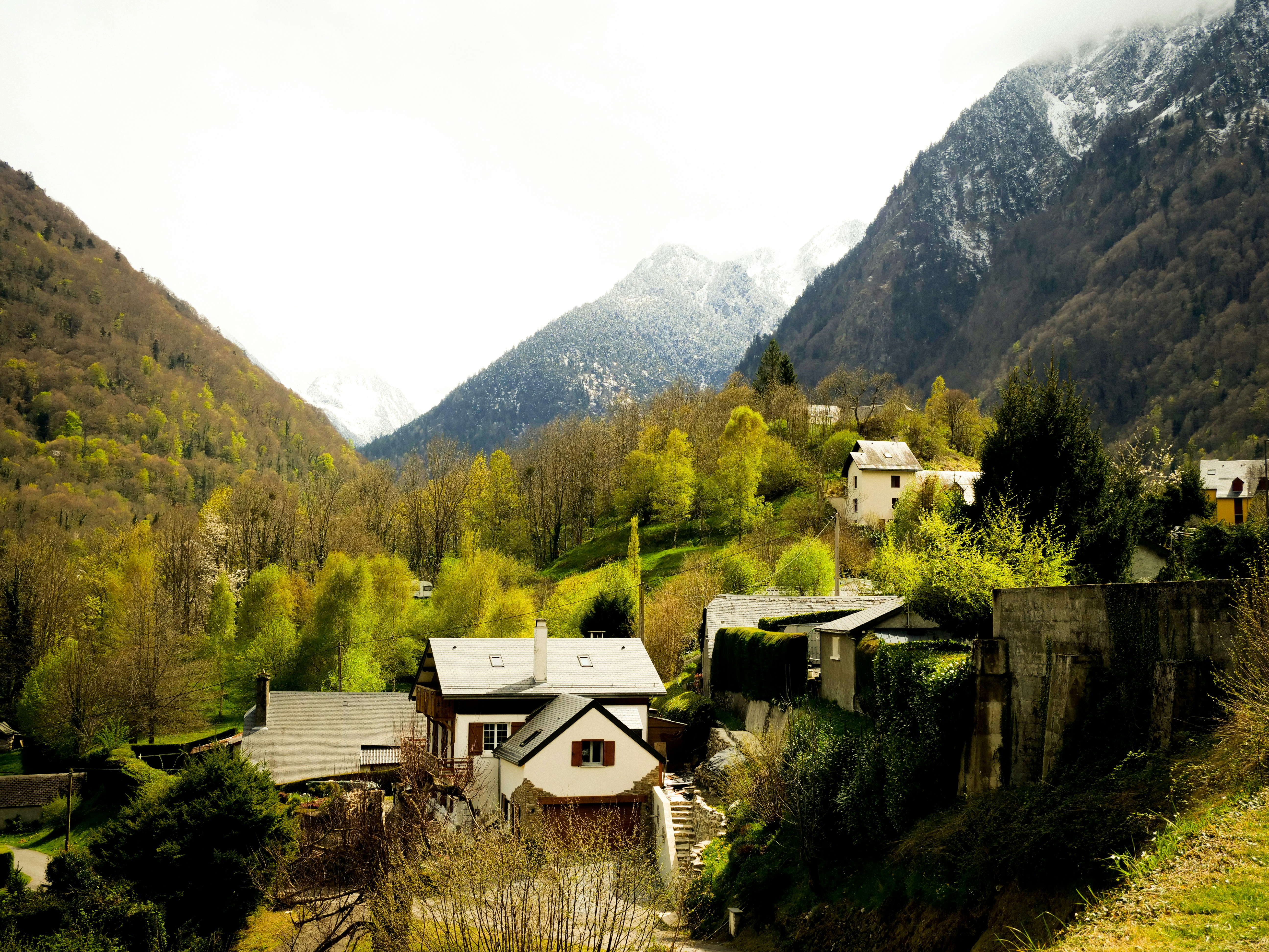 Alpine Village in Spring Light Beneath Snow-Kissed Peaks