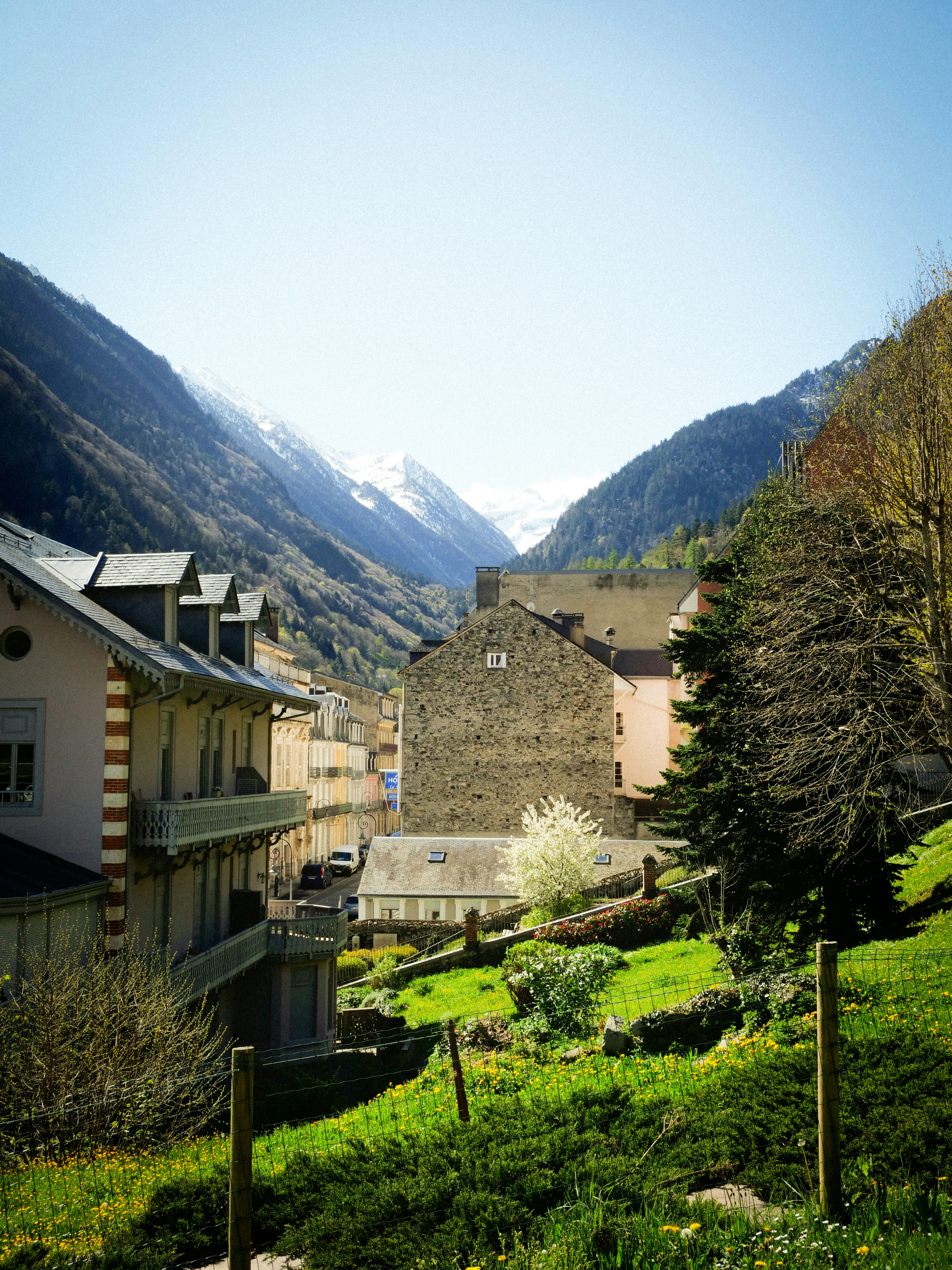Stone Alleys and Snow-Capped Vistas: An Alpine Village in Sunlit Valleys