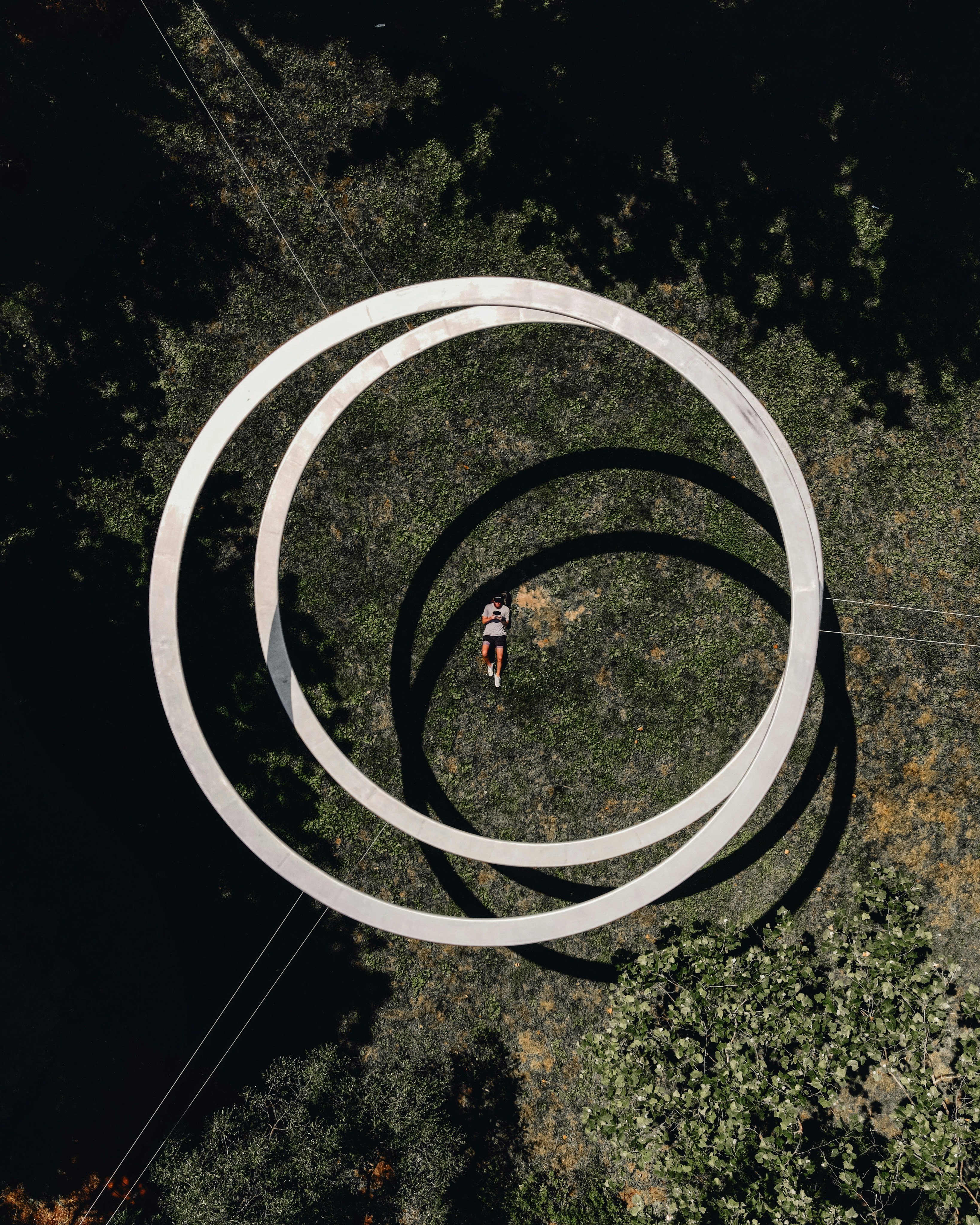 Two interlocking circles cast a shadow on a person. photo – Free ...