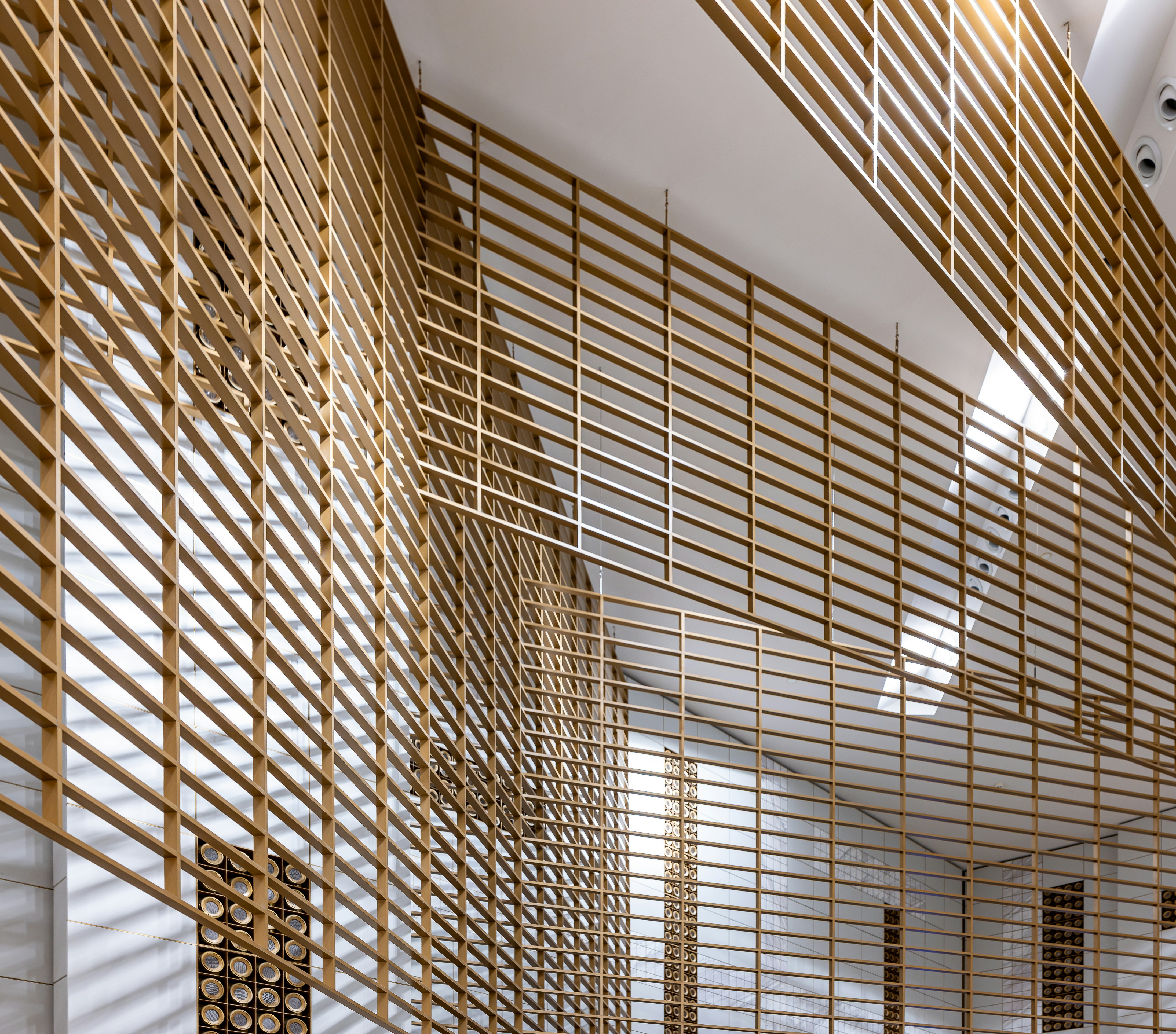 Golden lattice structures create intricate patterns on walls. photo ...