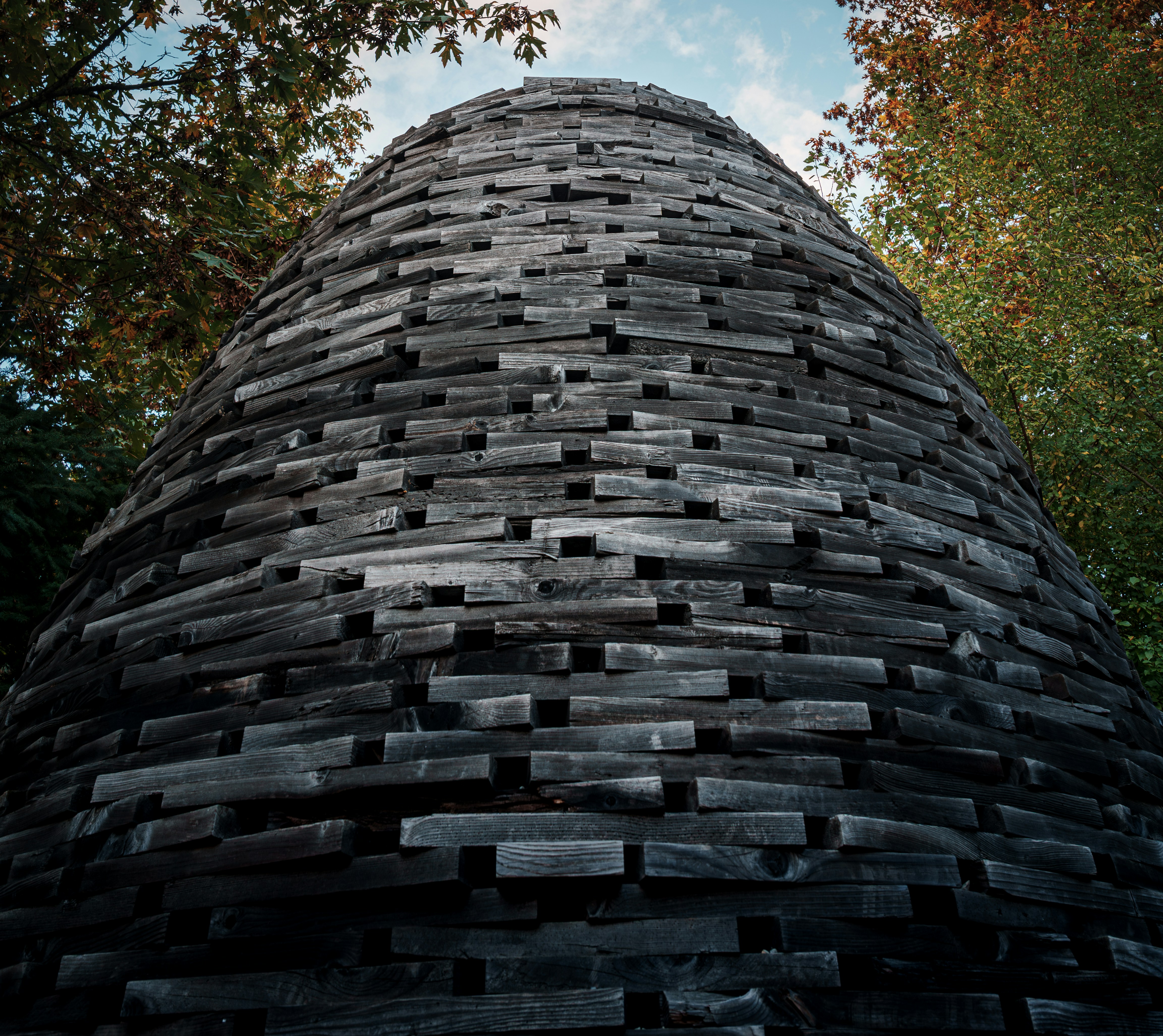 A wooden structure made of layered planks. photo – Free Building Image ...