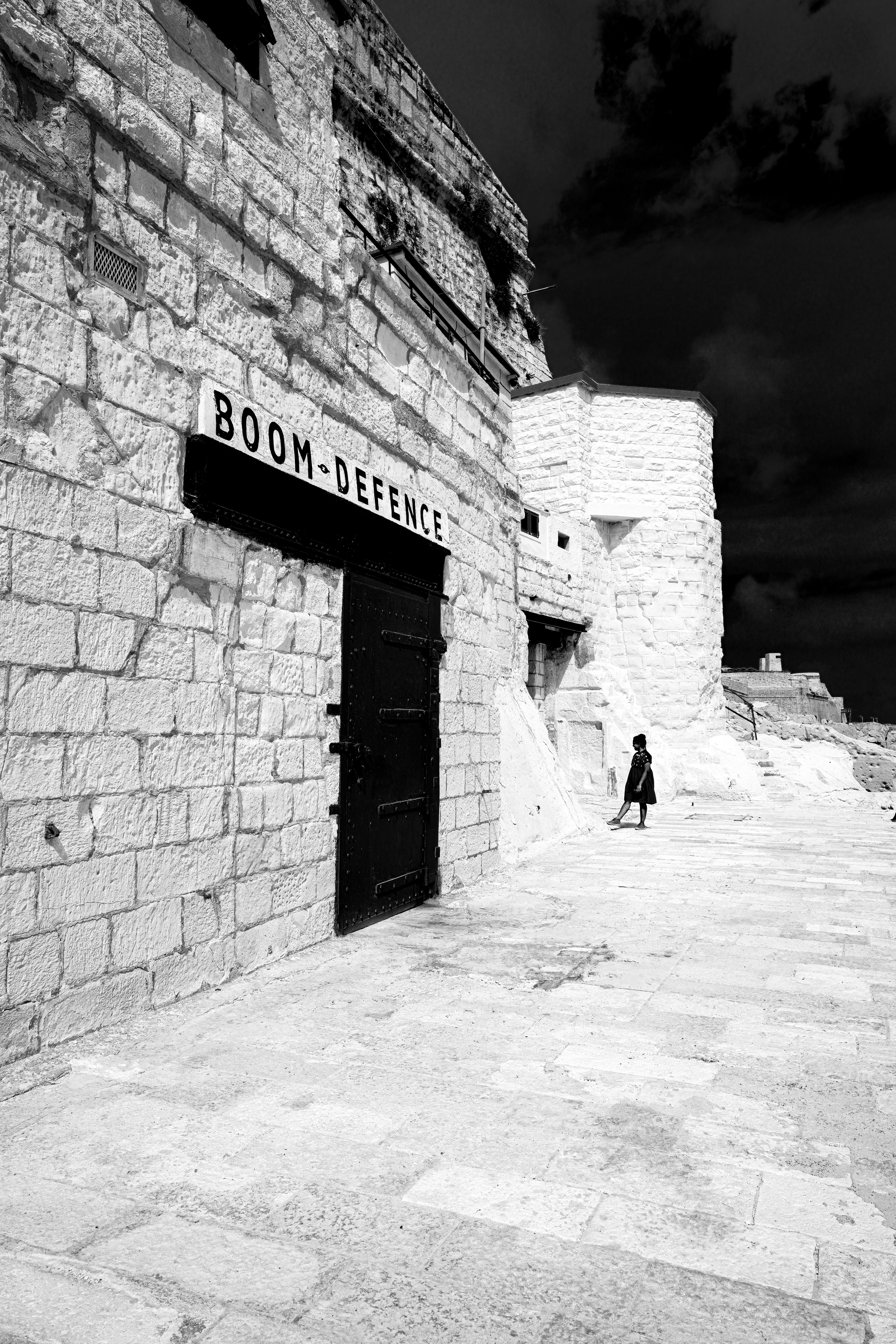 Lone Traveler at the Boom-Defence Gate of a Weathered Fortress