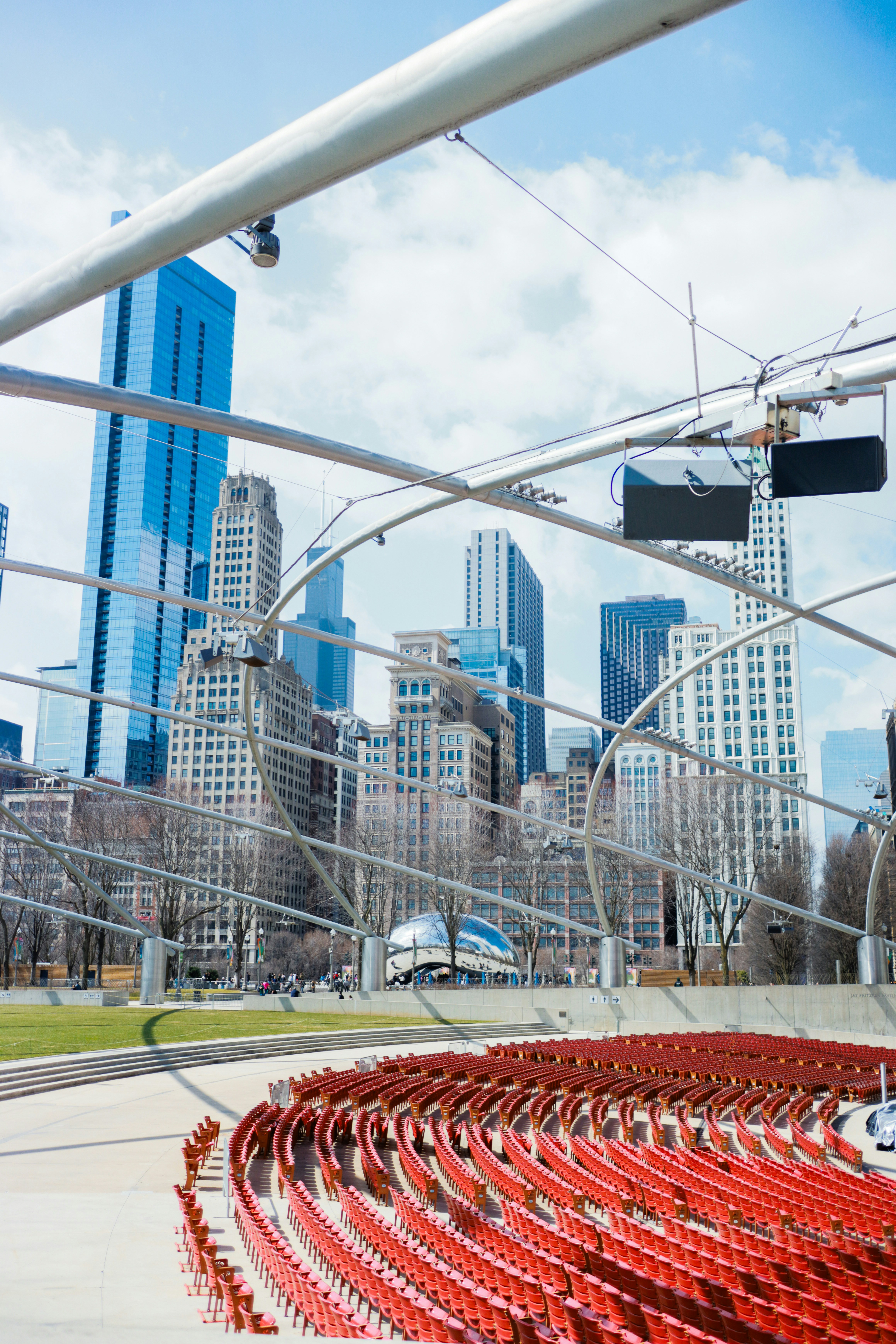Red-Chair Amphitheater Framing a Modern Skyline