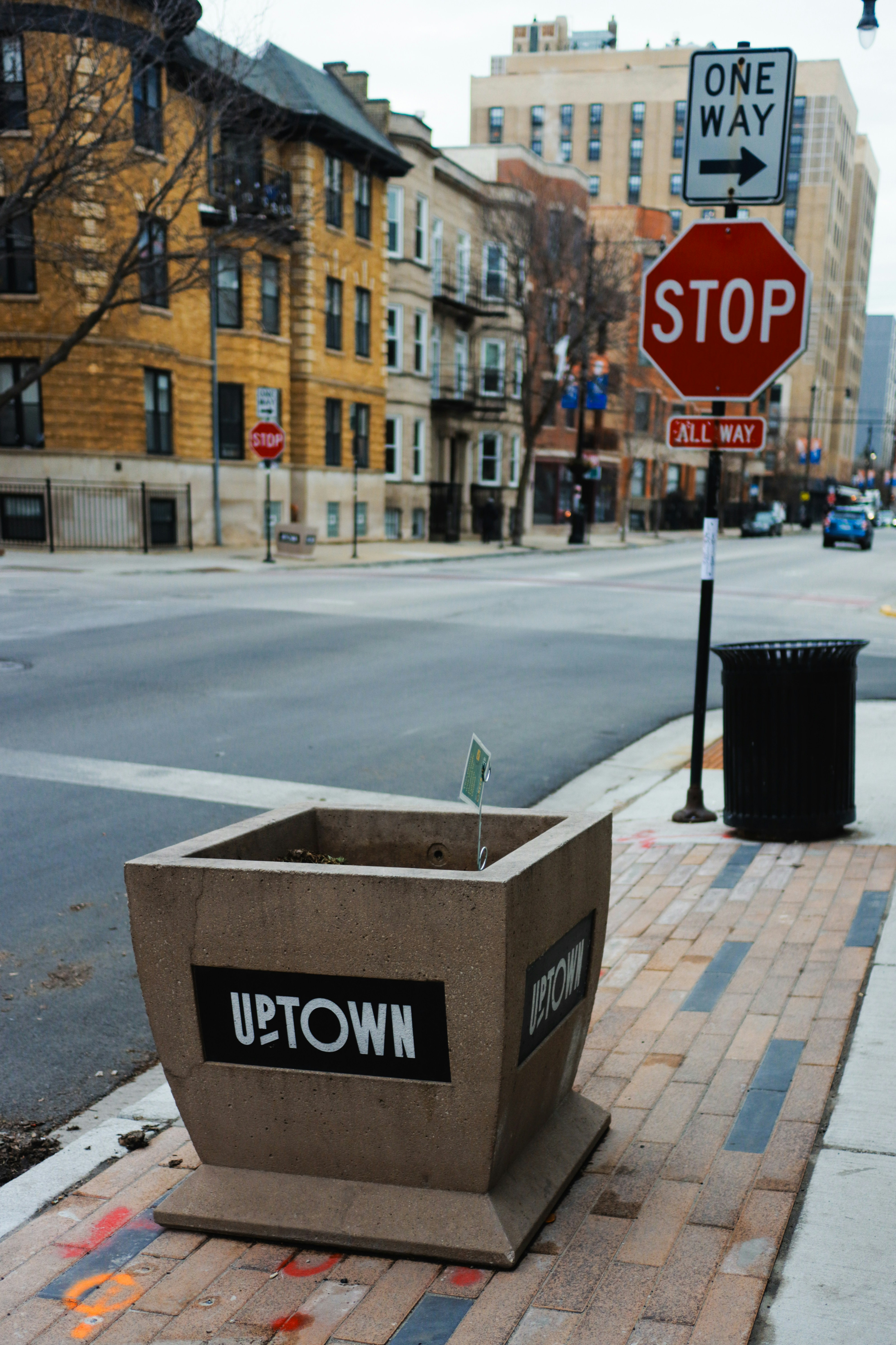 Uptown street with signs, buildings, and a planter. photo – Free Travel ...