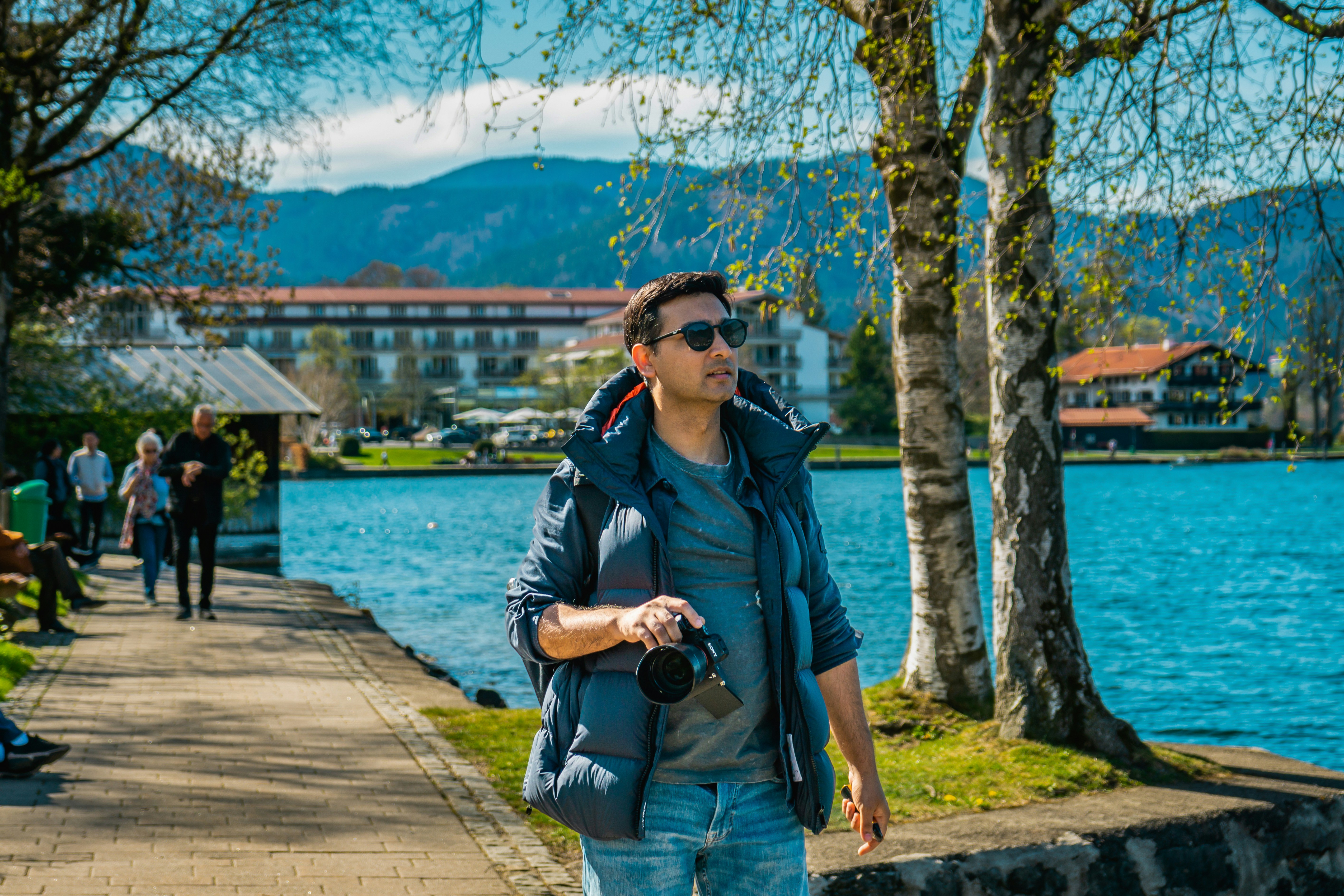 Man walking by a lake in a scenic landscape. photo – Free Free images ...