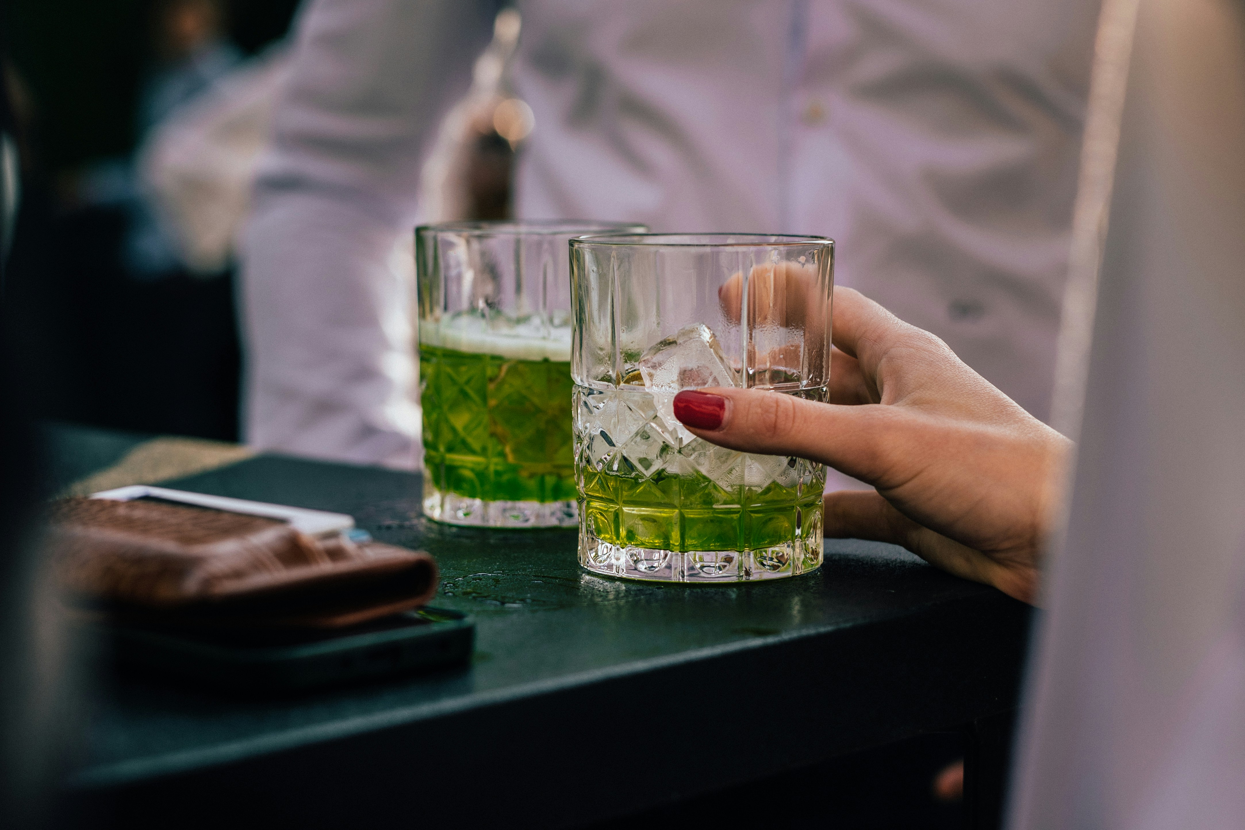 Emerald Sips and Ruby Nails: A Quiet Bar Moment