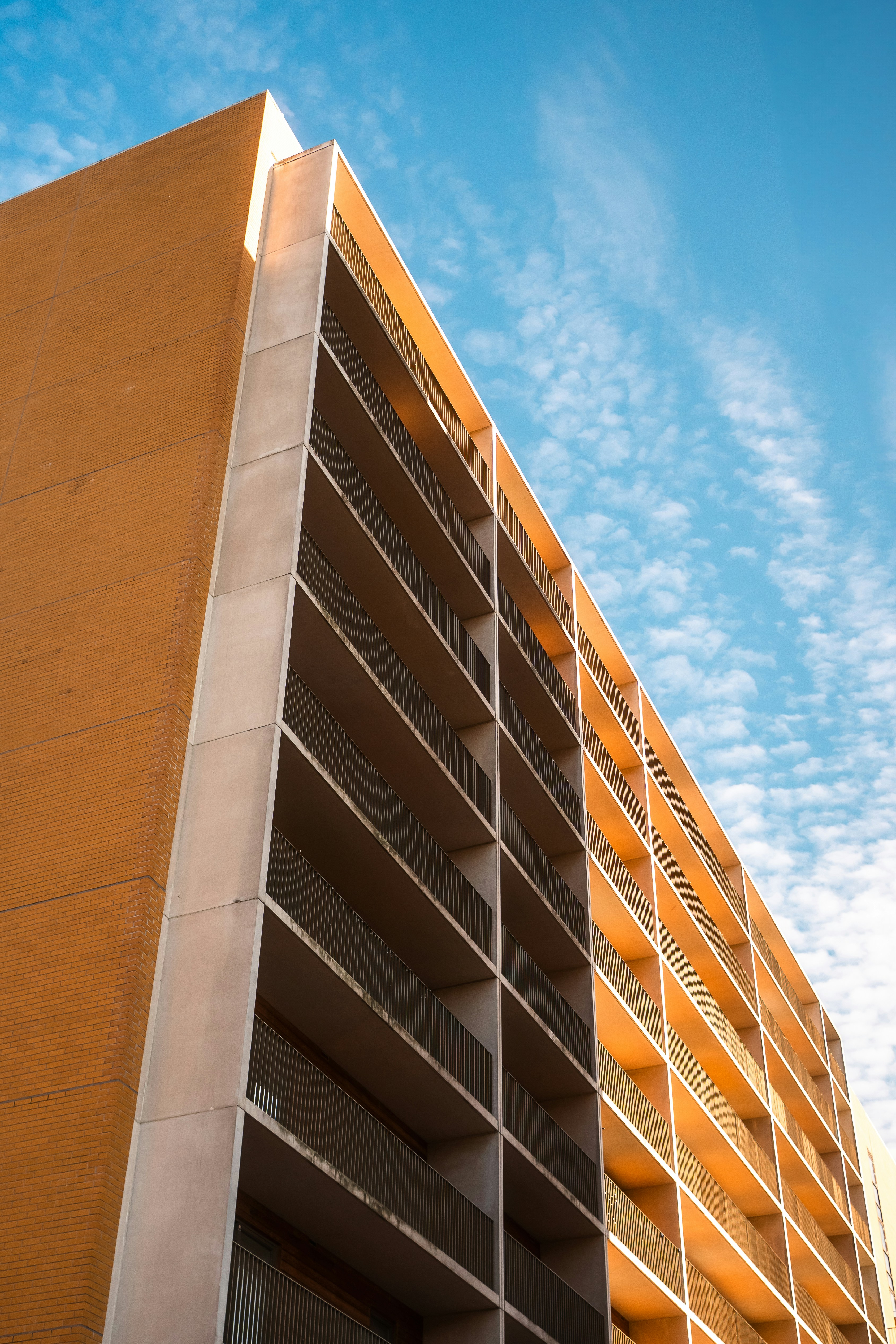 Tall building stretches towards a clear blue sky.