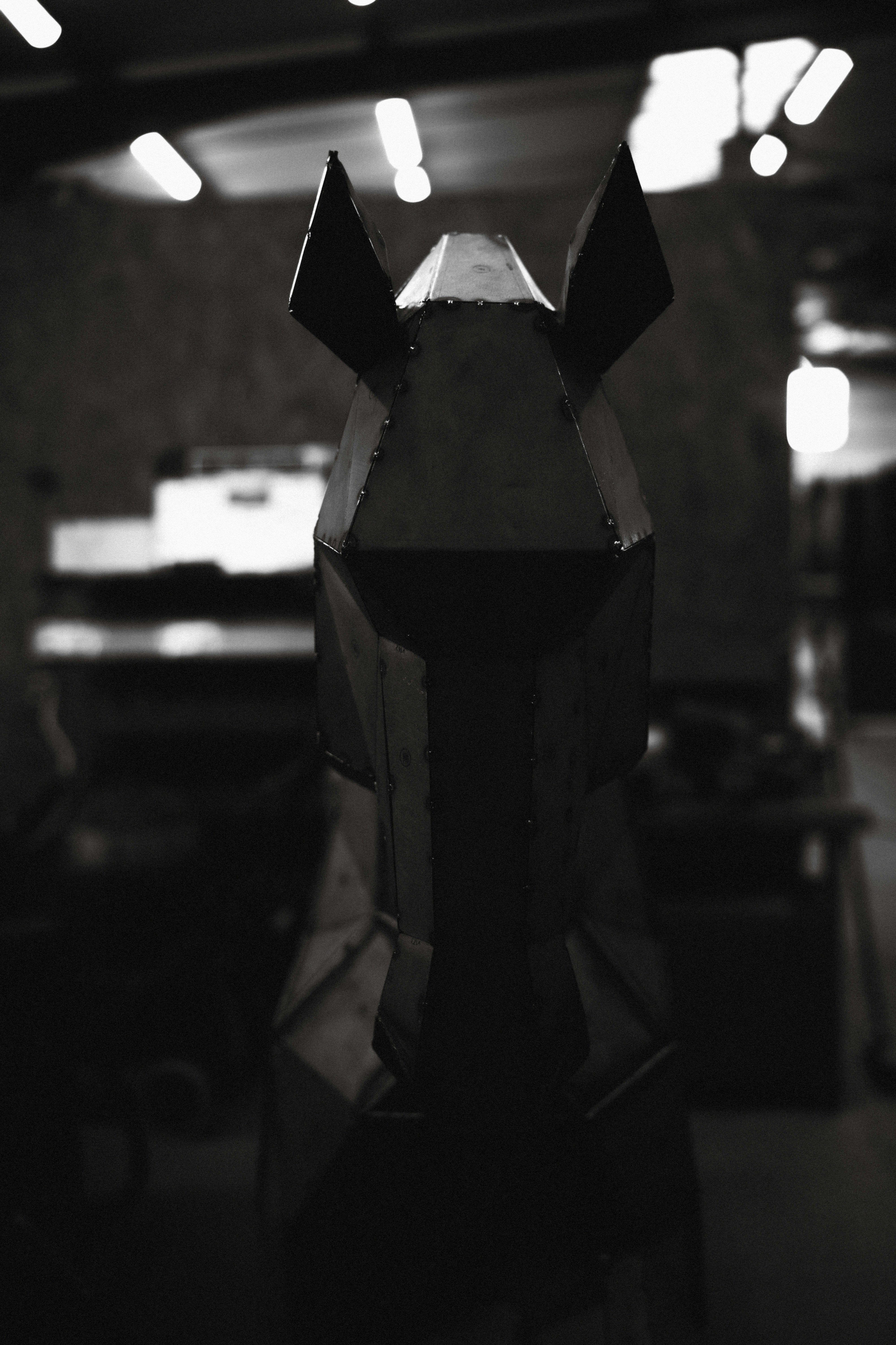 Faceted Equine in the Studio: A Monolithic Metal Horse Emerging from Shadow