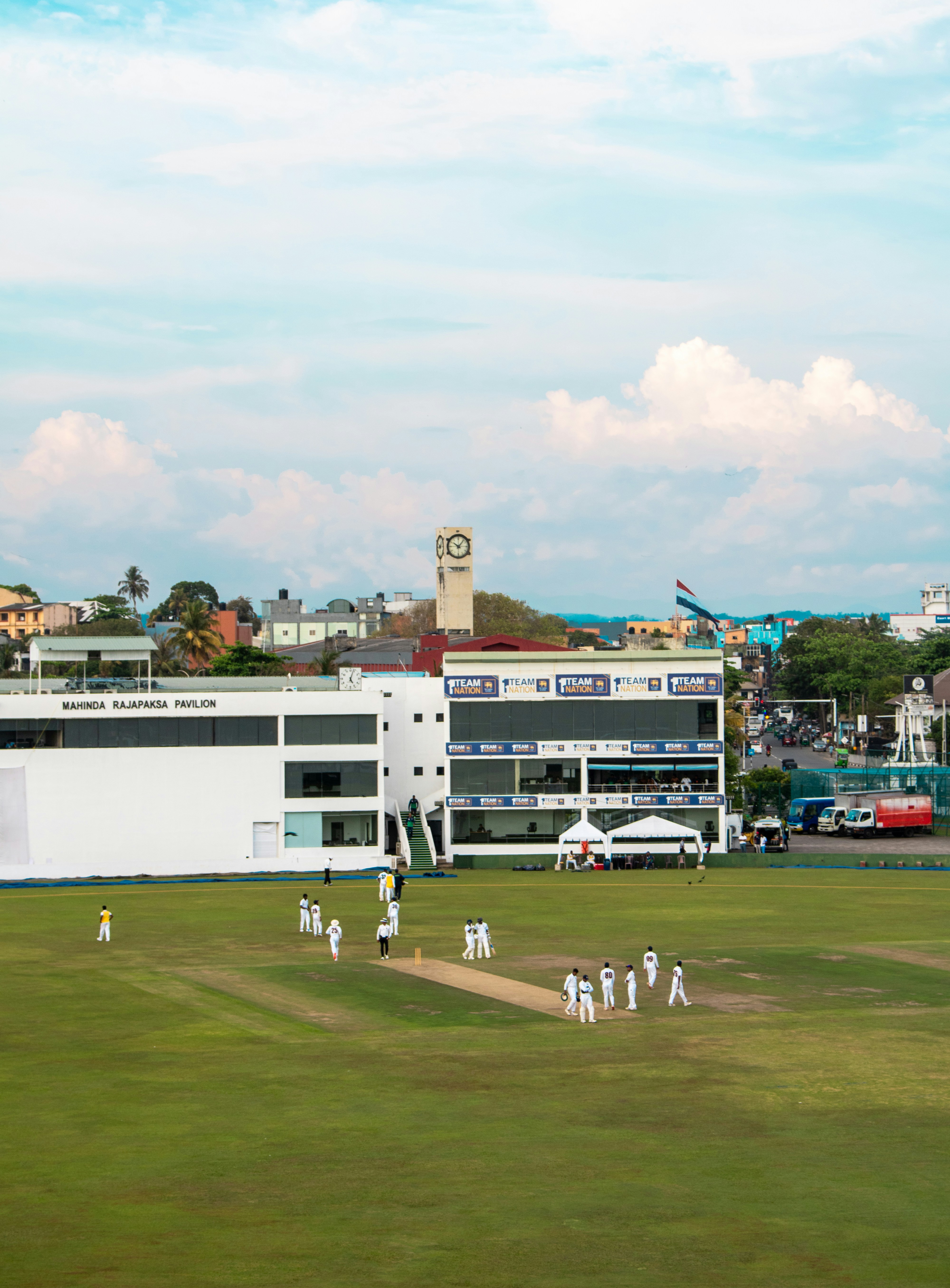 Cricketers are playing a match on a green field. photo – Free Team ...