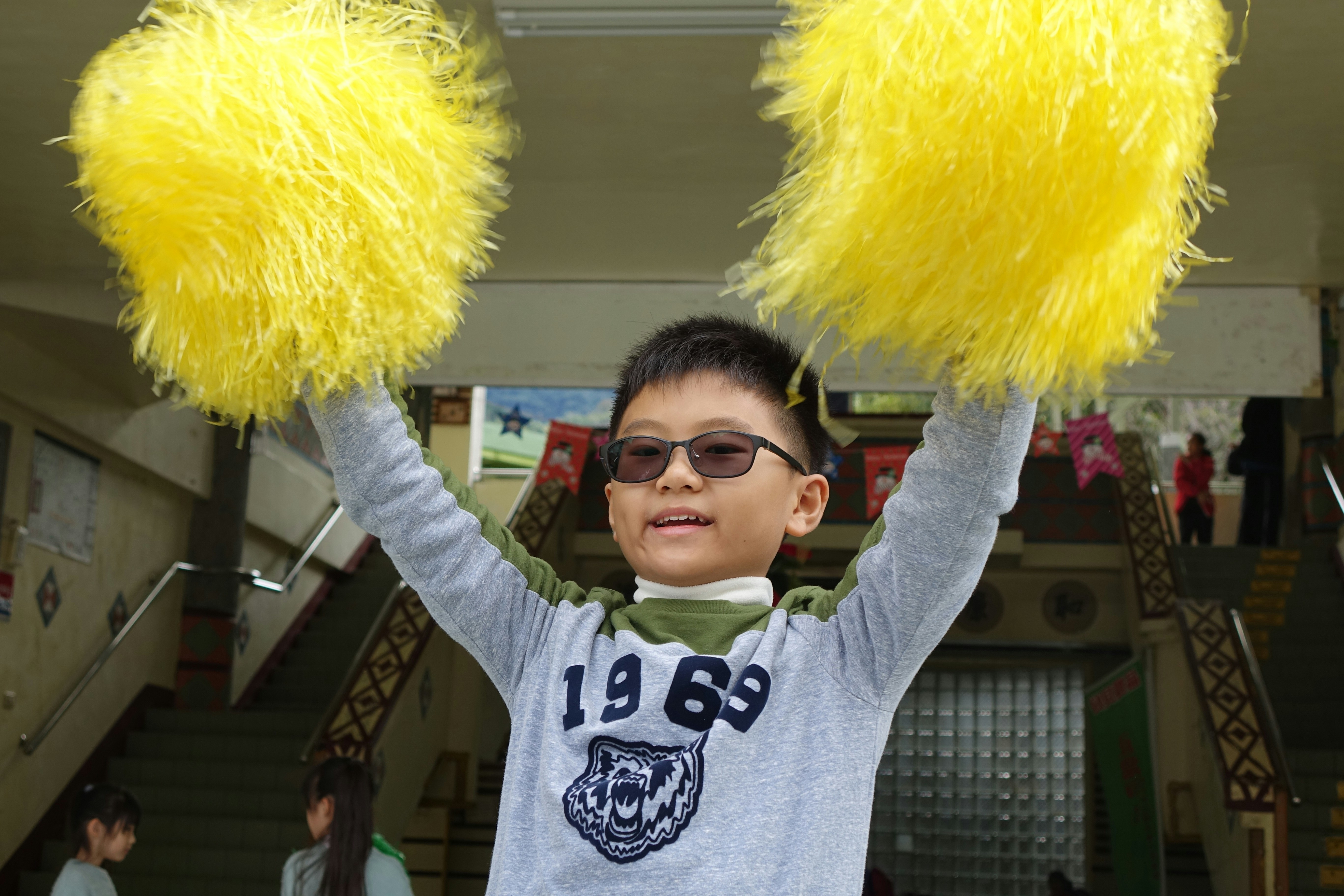 Young boy cheers with yellow pom-poms. photo – Free Girl Image on Unsplash