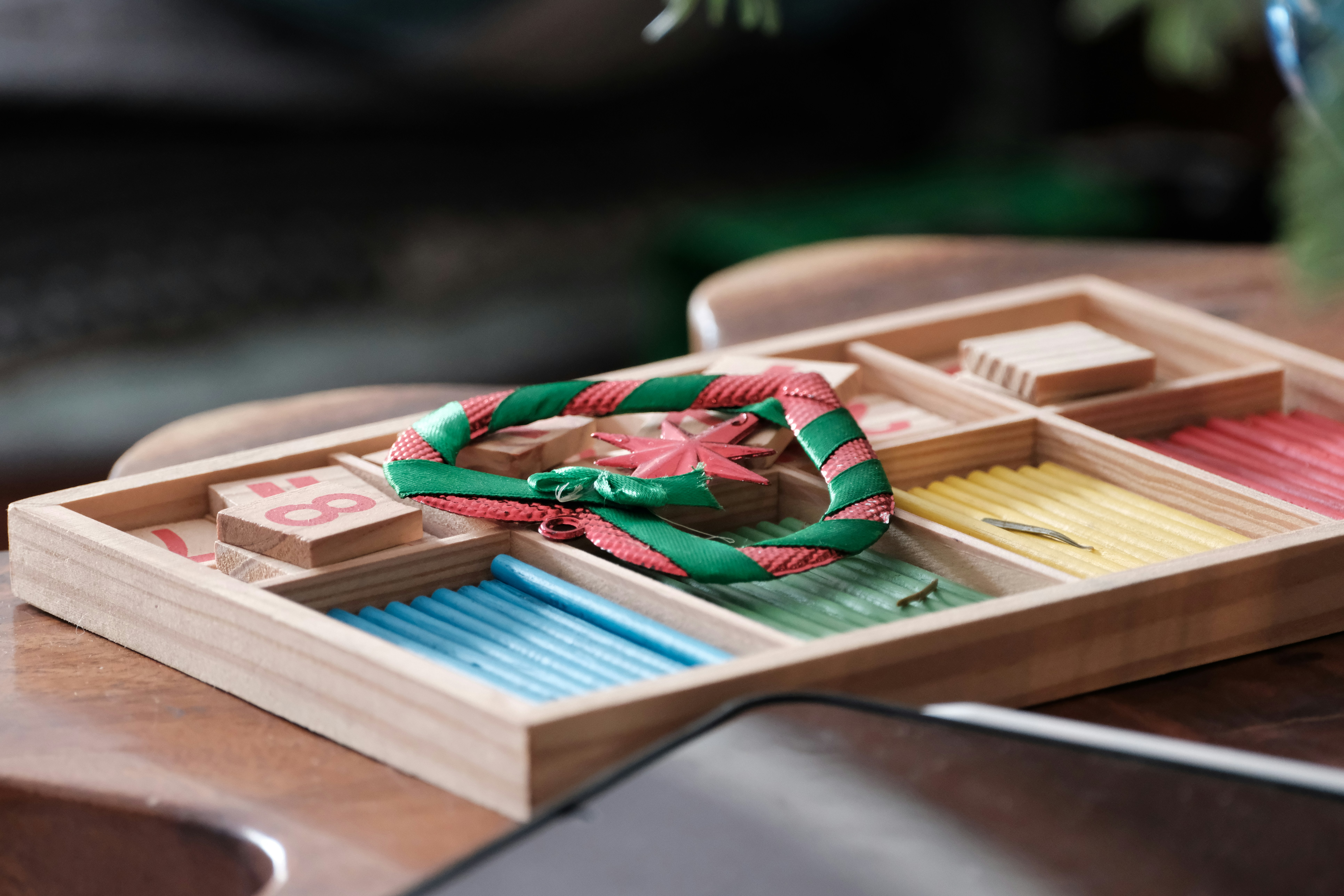 Wooden educational counting set featuring colorful sticks and number blocks arranged neatly in a tray.