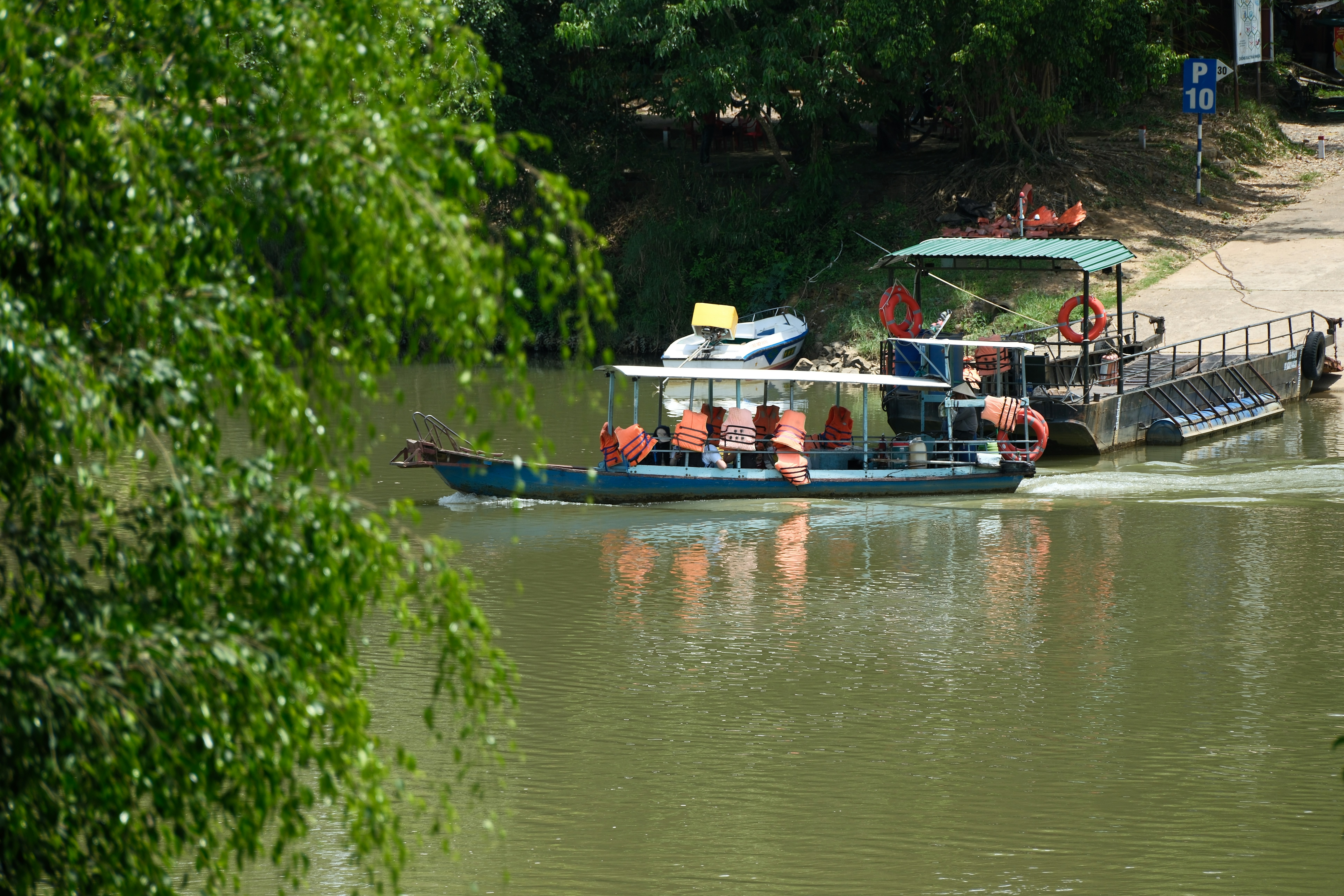 Riverside Moor: A Quiet Boat Resting by the Green-Shaded Dock