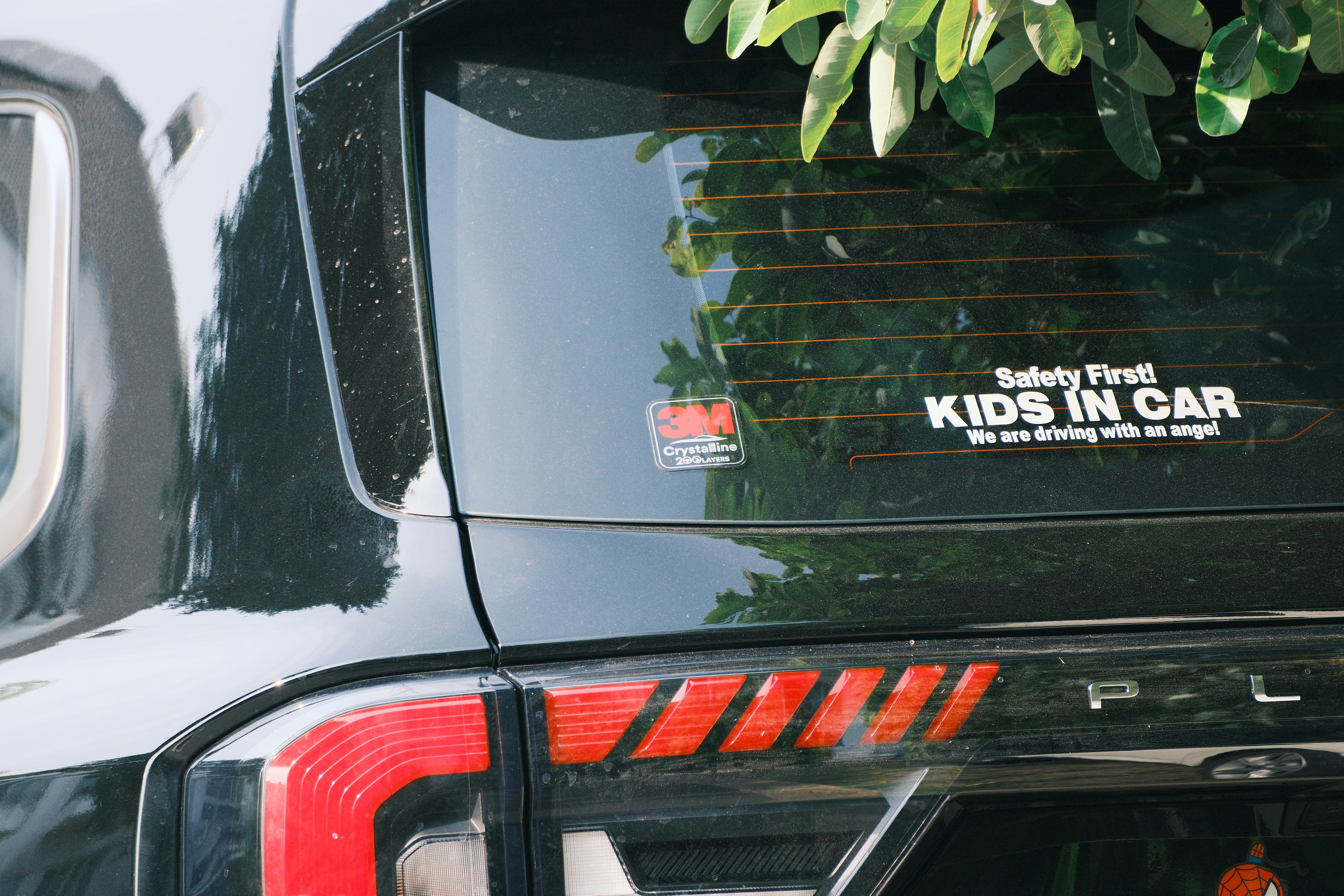 Safety First Sticker: Kids In Car on a Glossy Black SUV