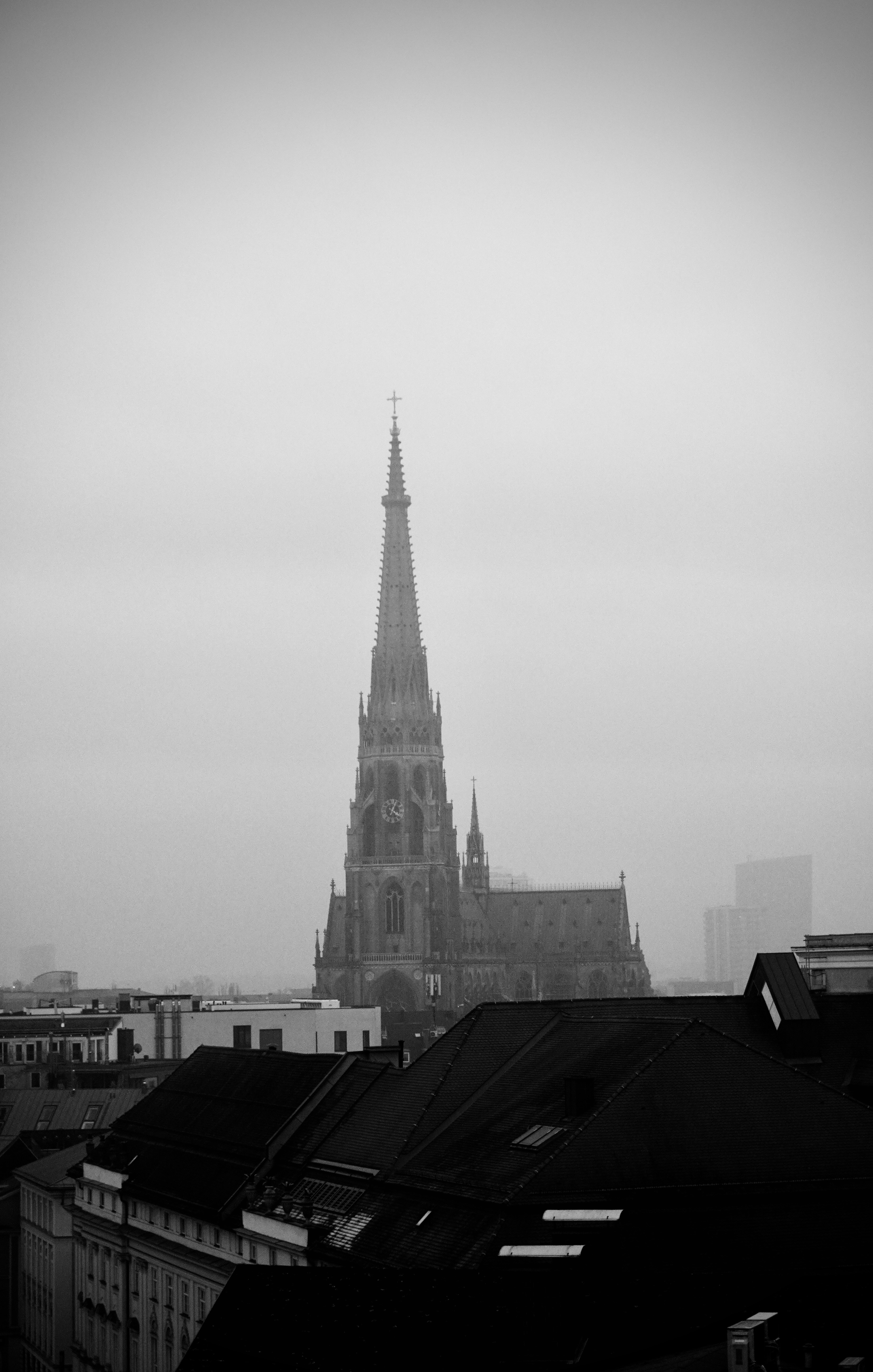 Fogbound Spire: A Gothic Cathedral Rising Over City Rooftops