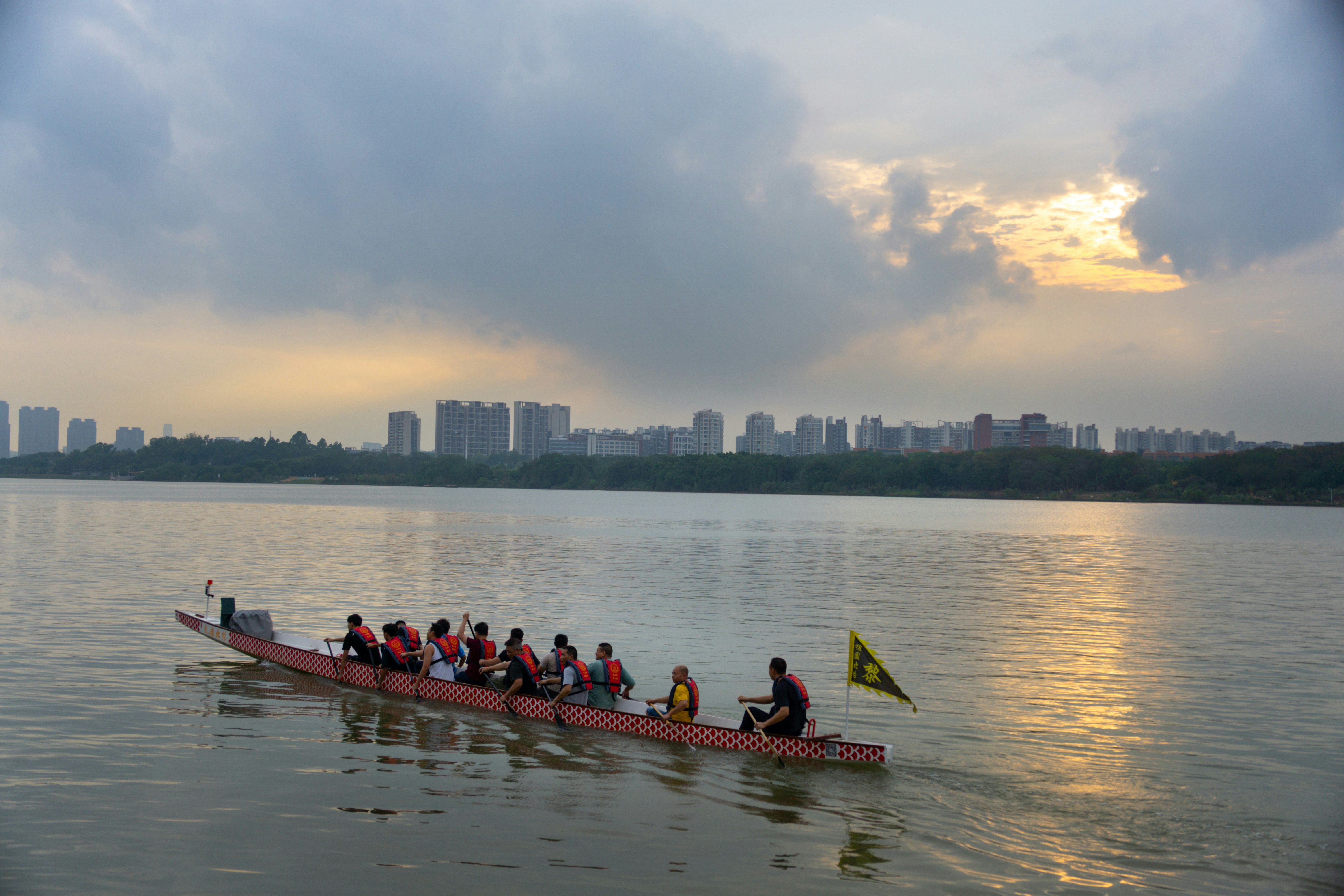 Dragon boat crew rows on a reflective body of water. photo – Free Human ...