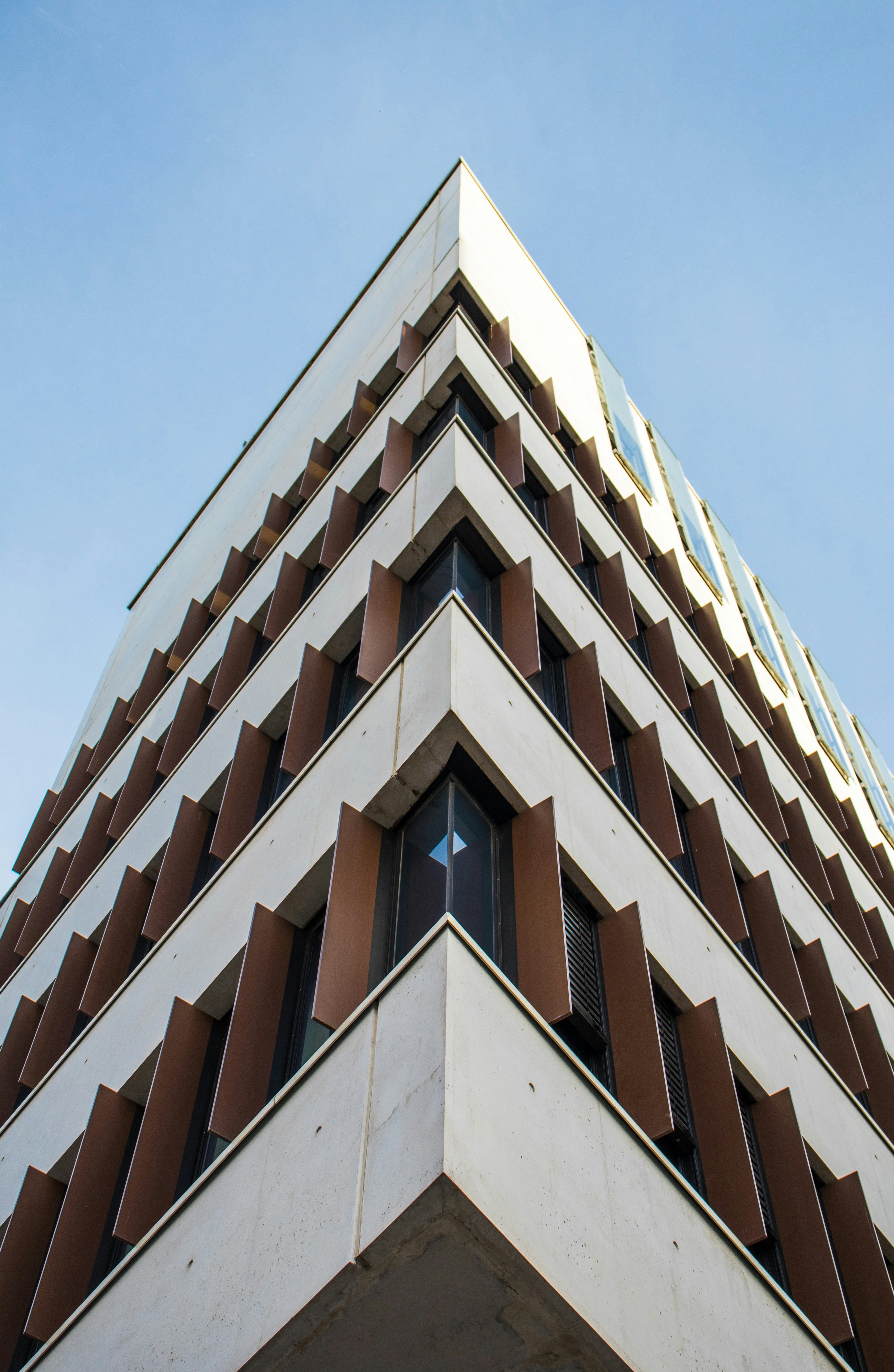 A modern building rises against a clear sky. photo – Free Building ...