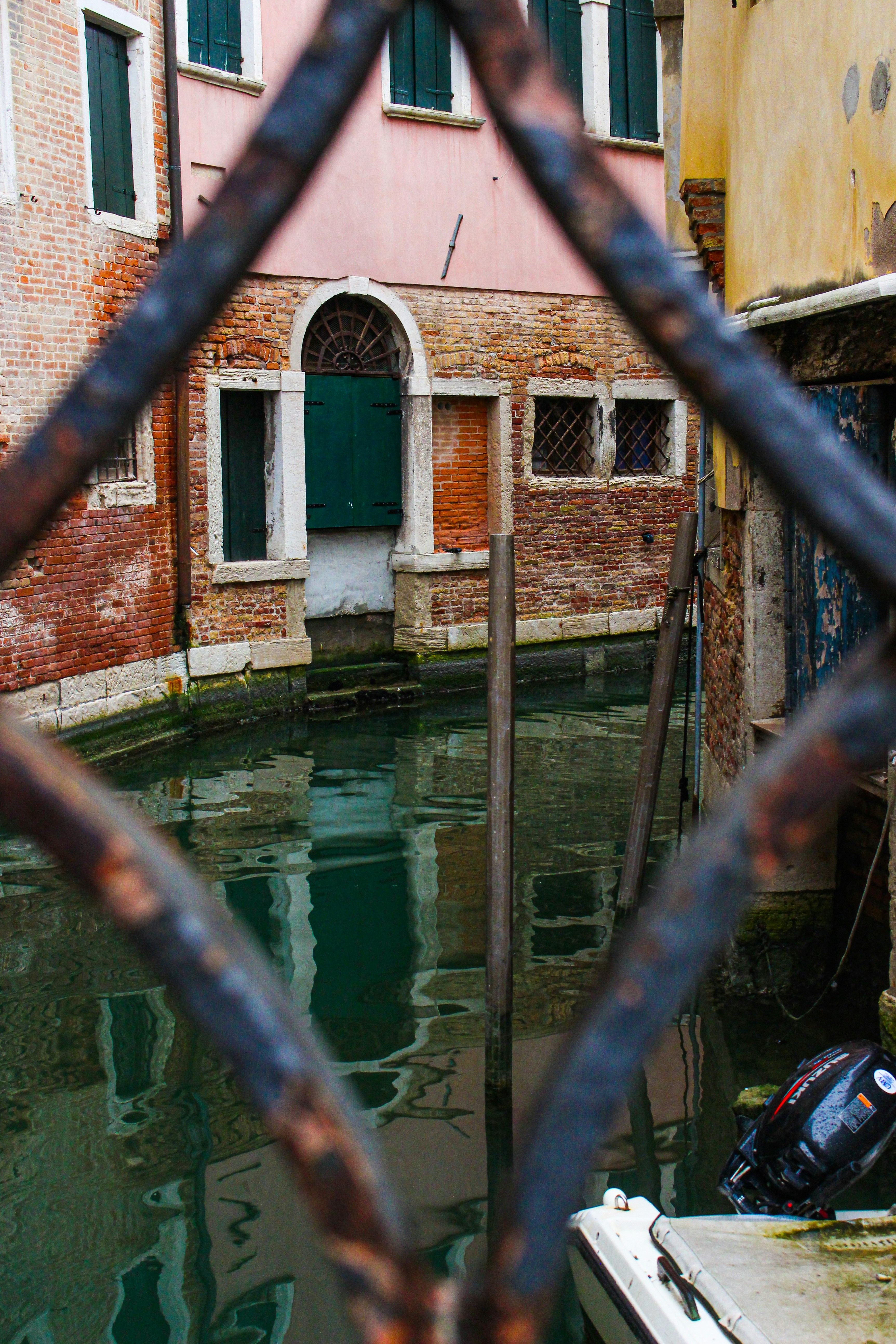 Veiled Canal Through a Weathered Gate