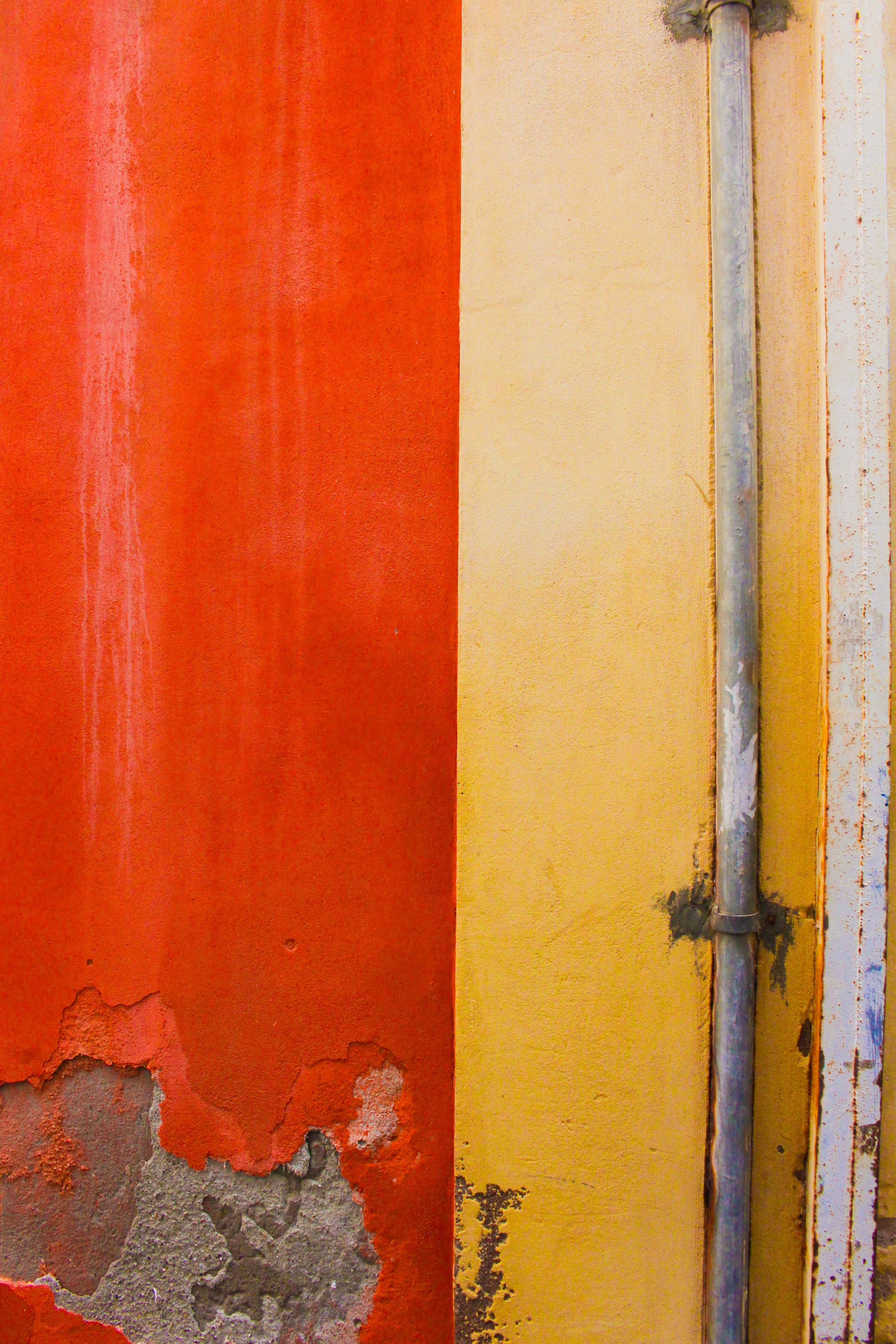 Red and yellow walls with a pipe. photo – Free Wall Image on Unsplash