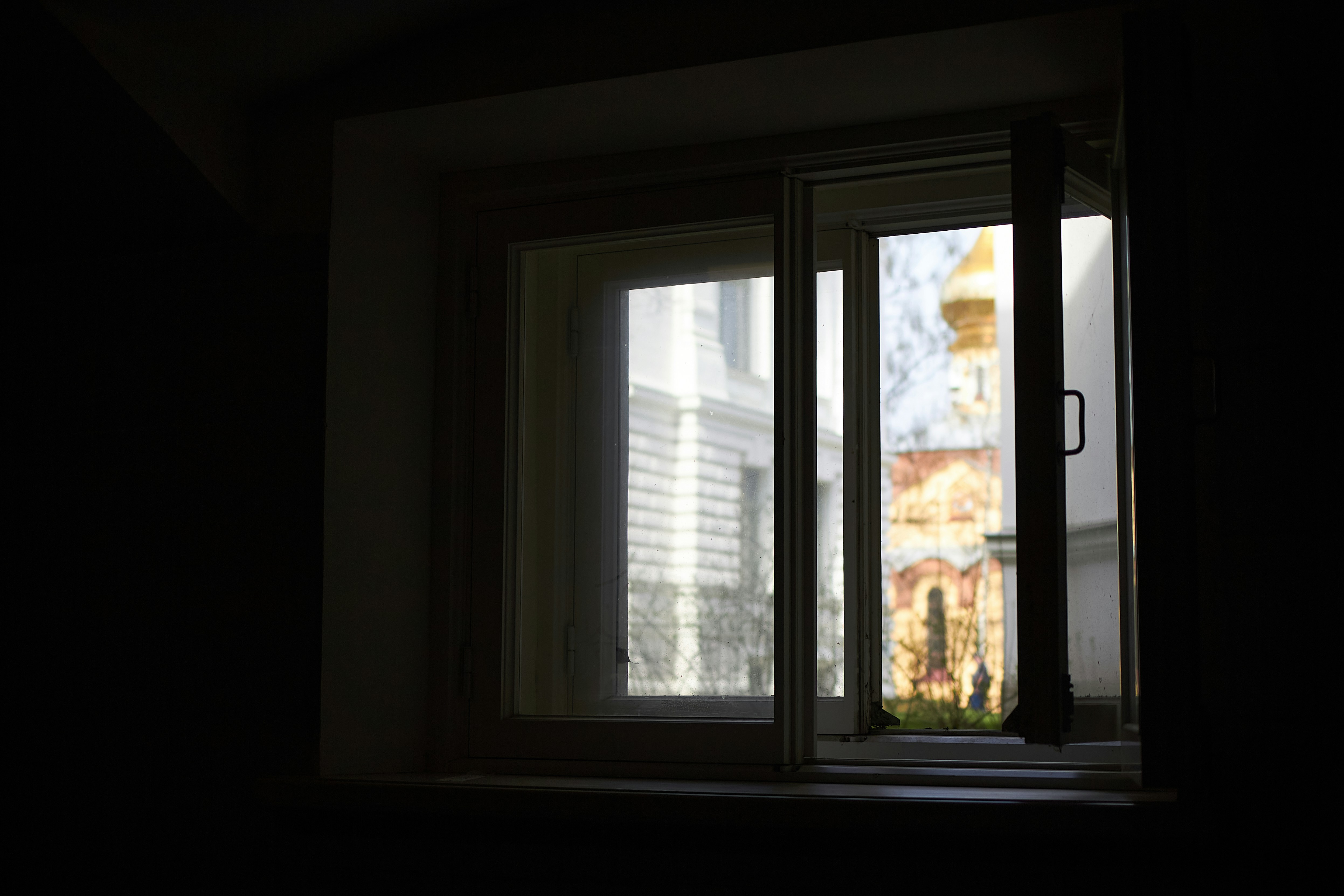 Light streams through a window into a dark room. photo – Free Building ...
