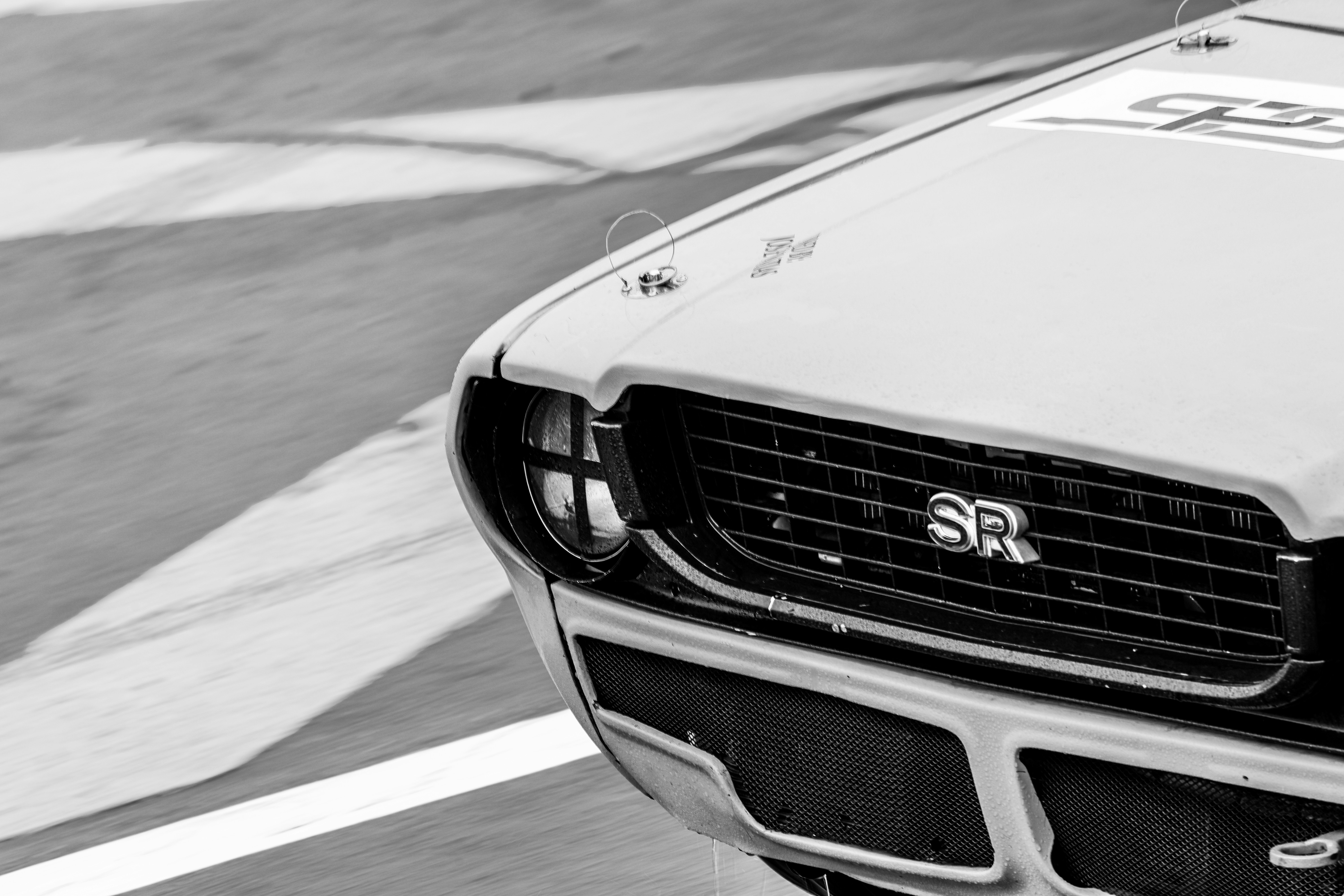 Chrome Grille in Motion: A Vintage Muscle Car at the Corner