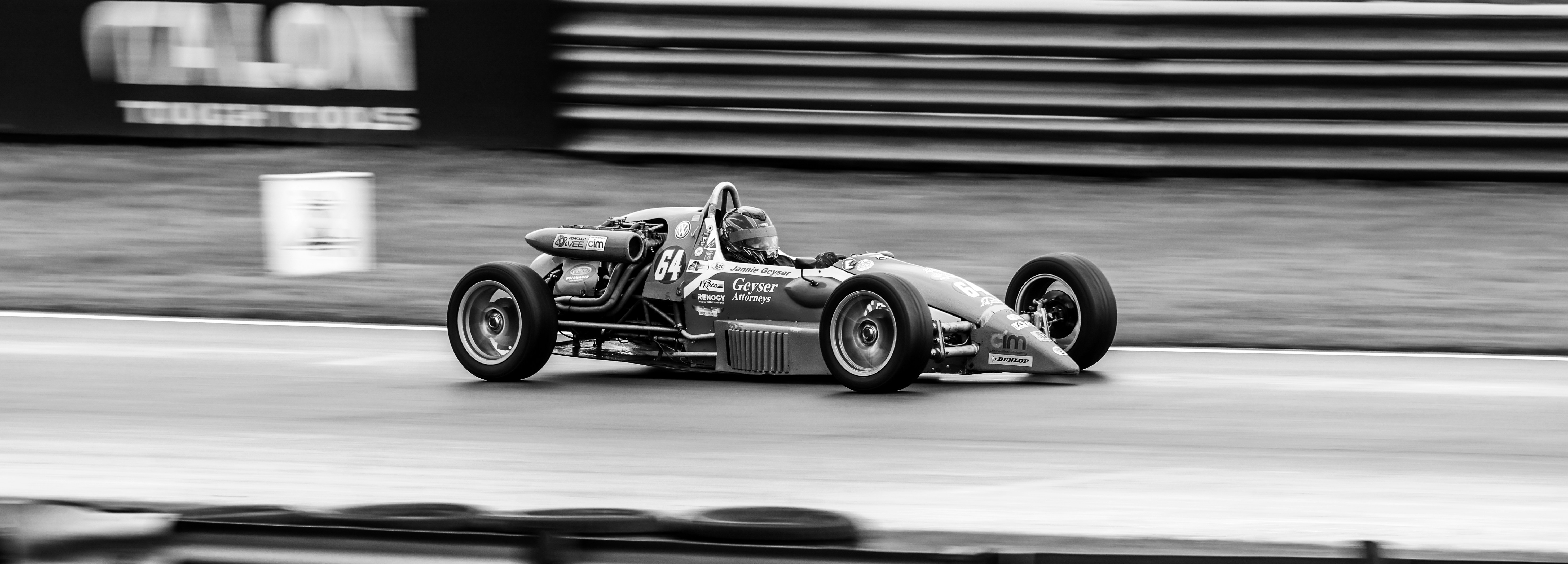 Monochrome Momentum: A Vintage Open-Wheel Racer in Full Tilt